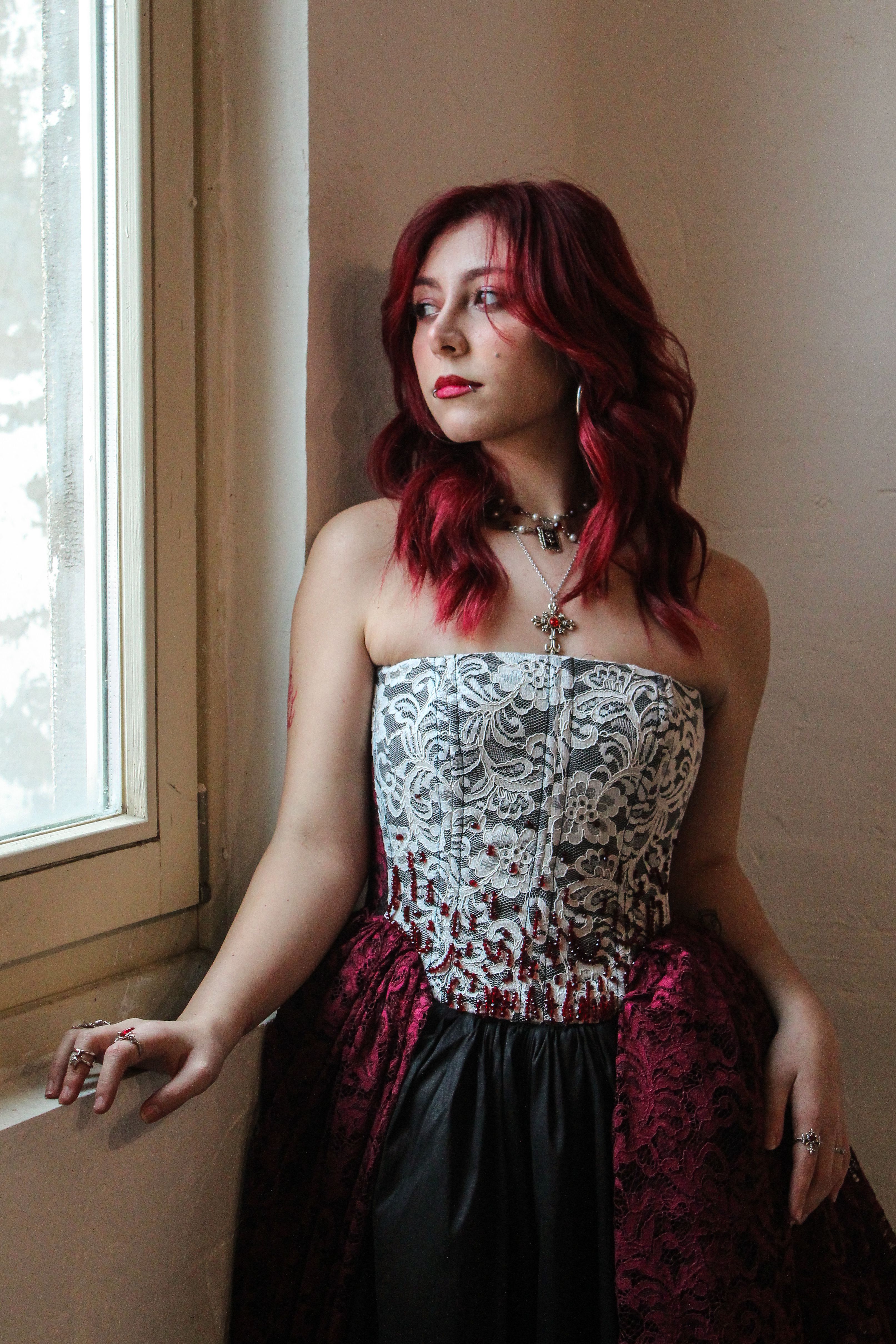 Elegant Woman in Lace Corset by Window · Free Stock Photo