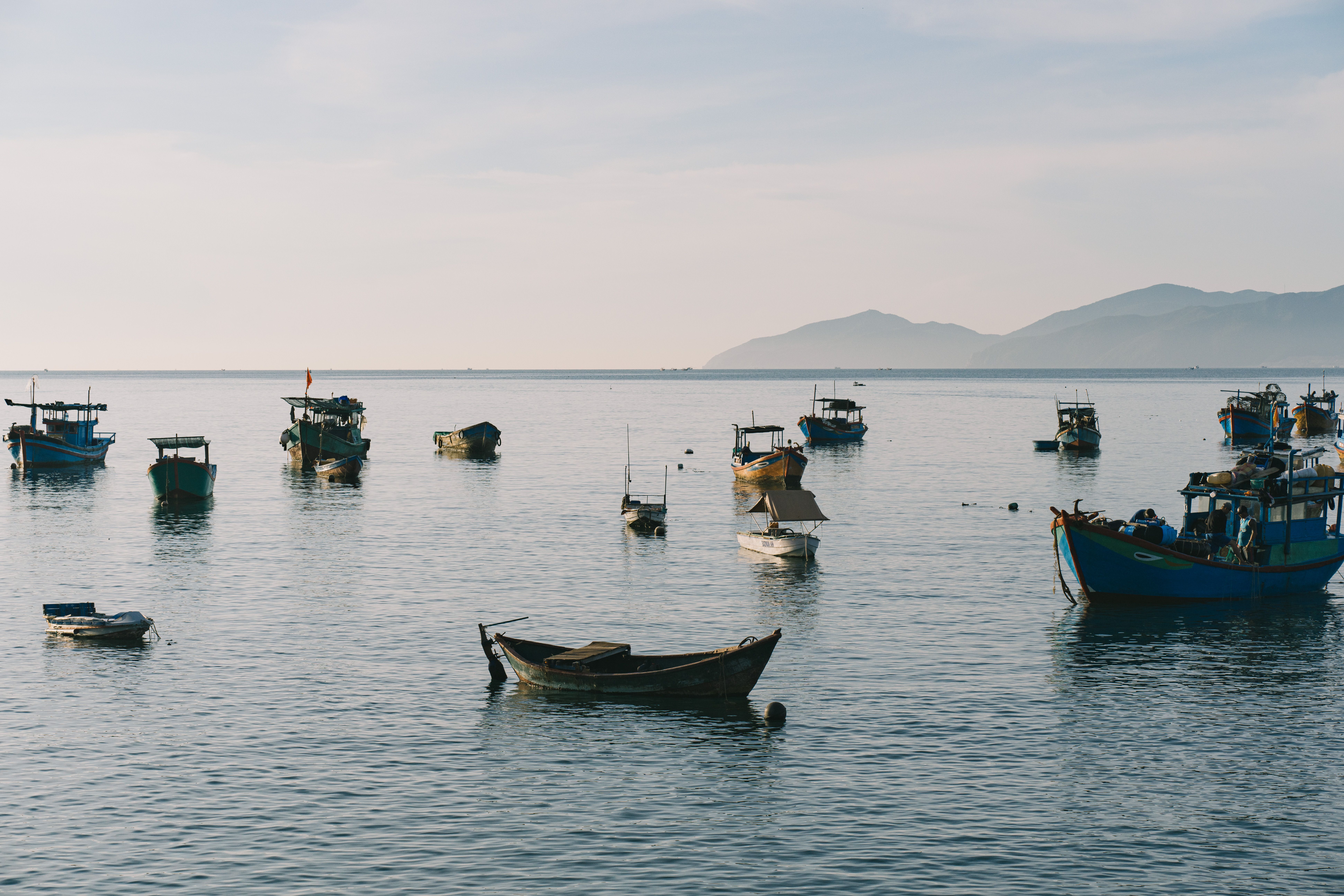 Serene Coastal Scene with Fishing Boats · Free Stock Photo