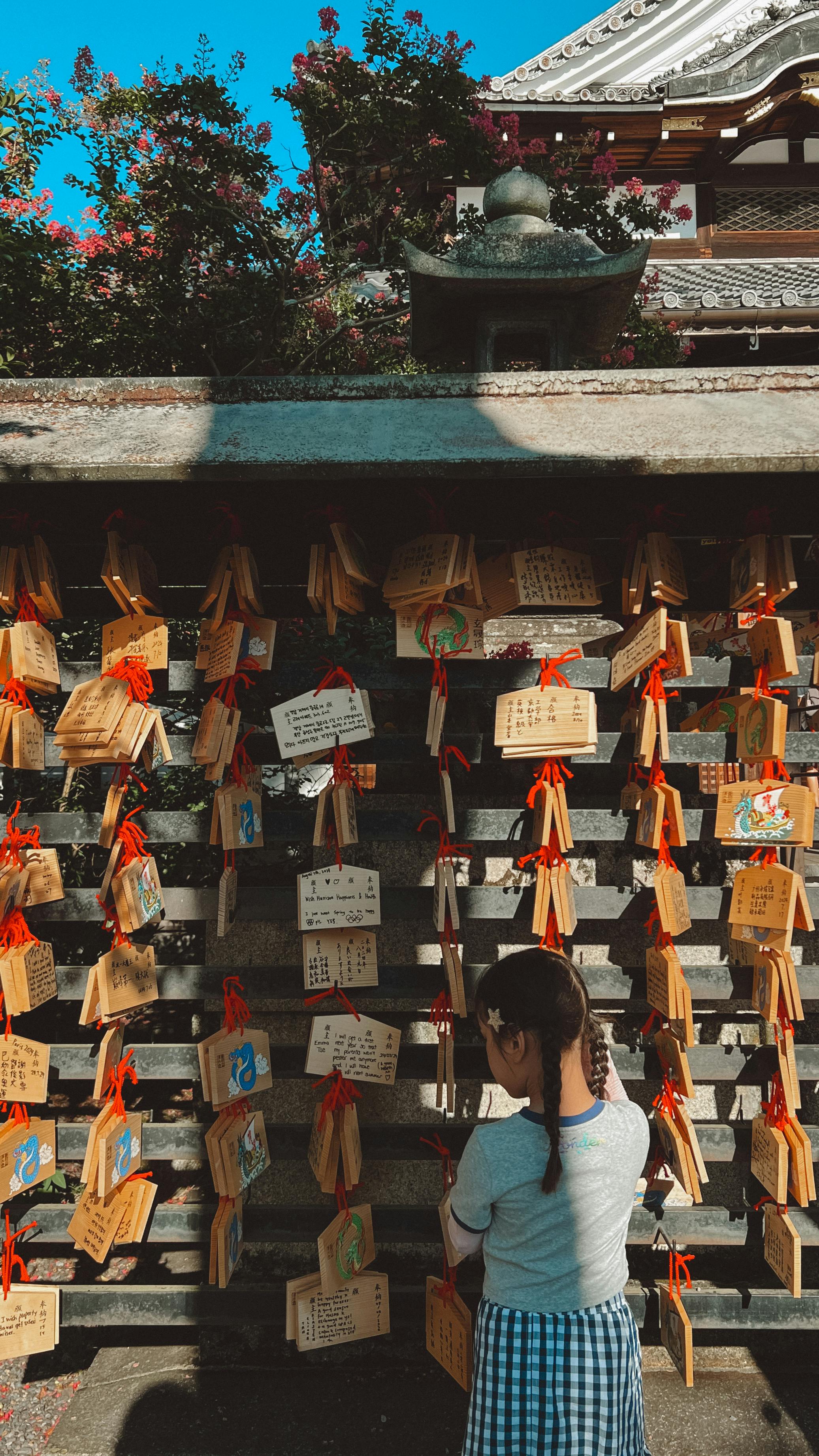 Young Girl Observing Ema Plaques in Kyoto Temple · Free Stock Photo
