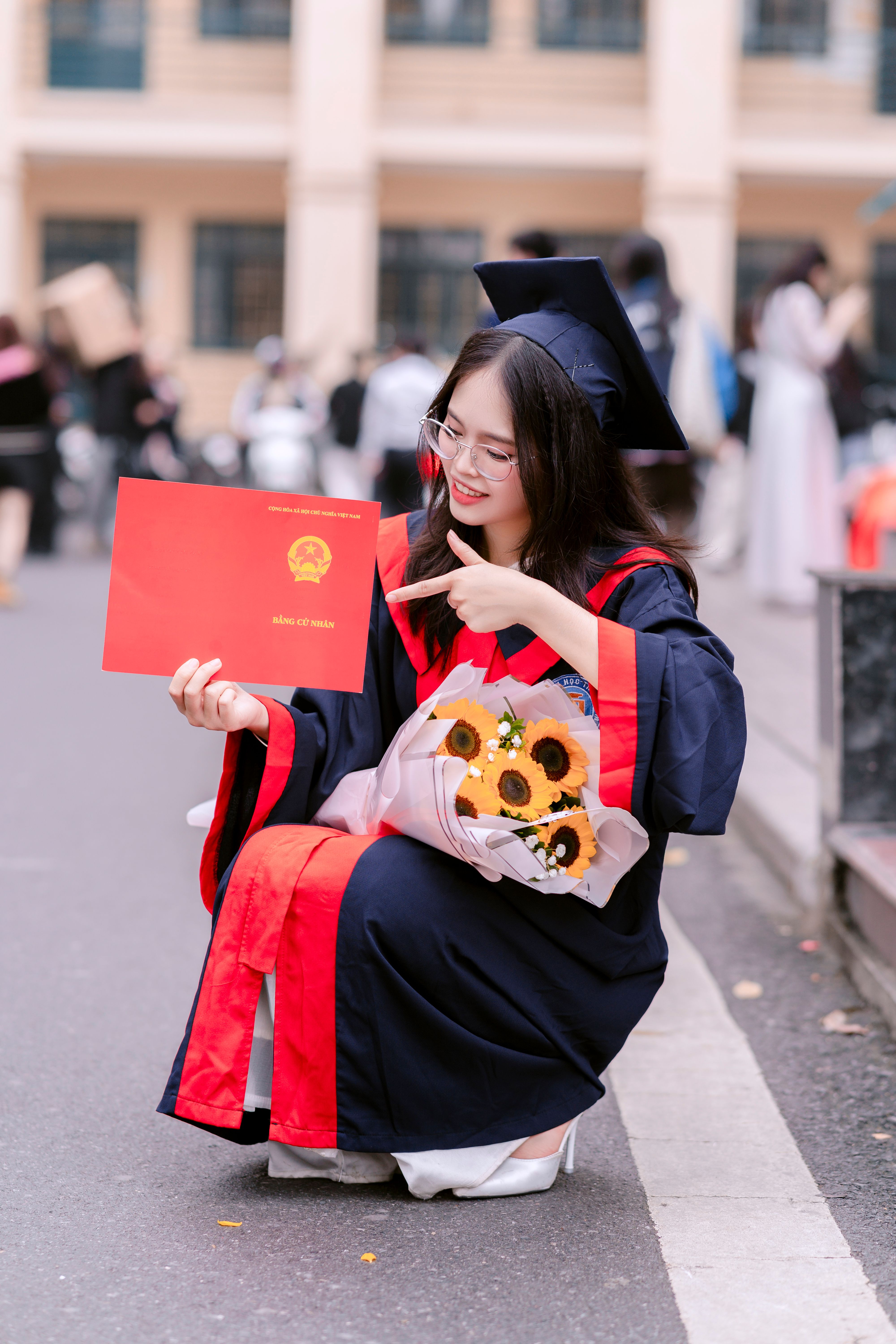 Graduation Celebration with Diploma and Flowers · Free Stock Photo