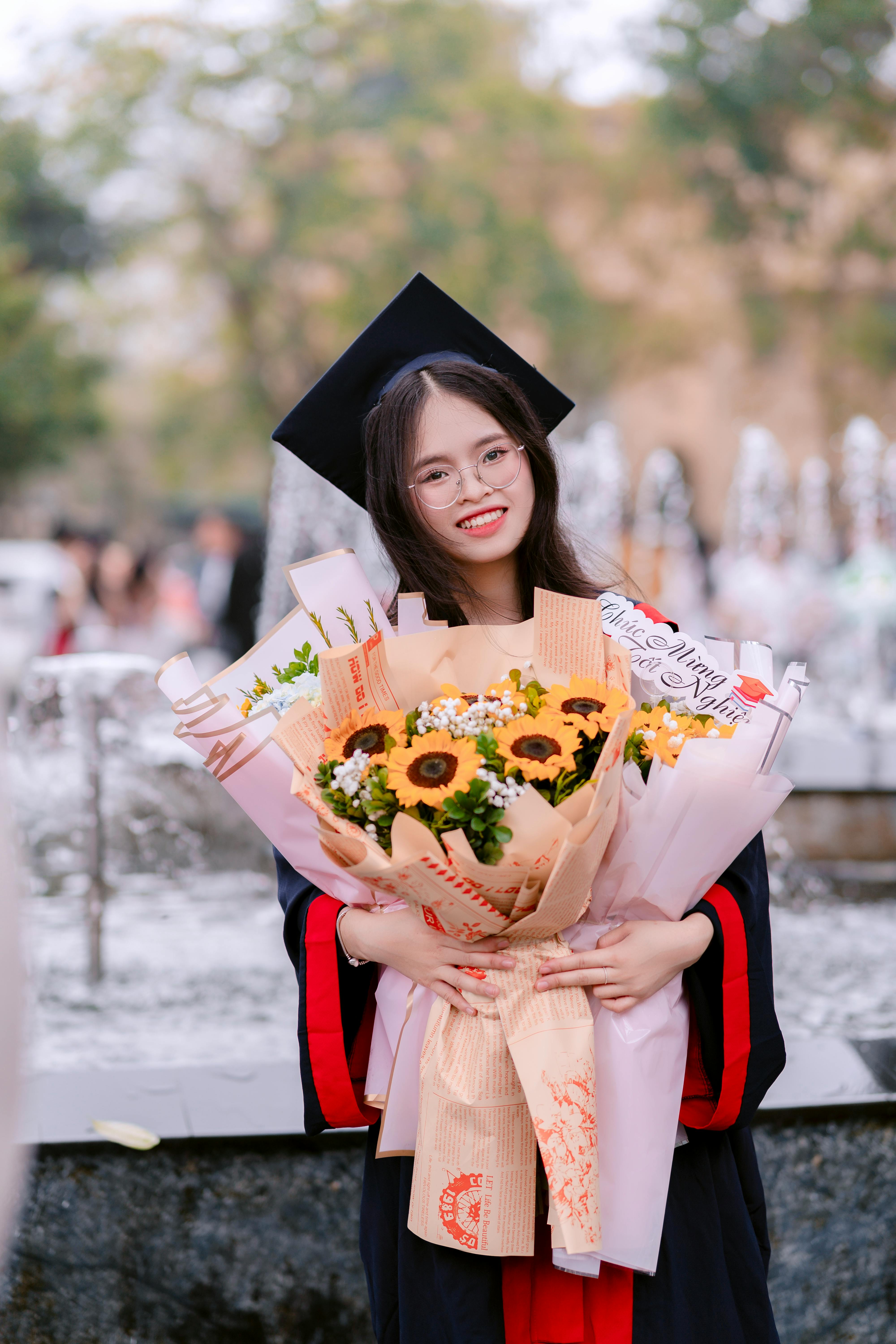 Two Friends Celebrating Graduation Outdoors · Free Stock Photo