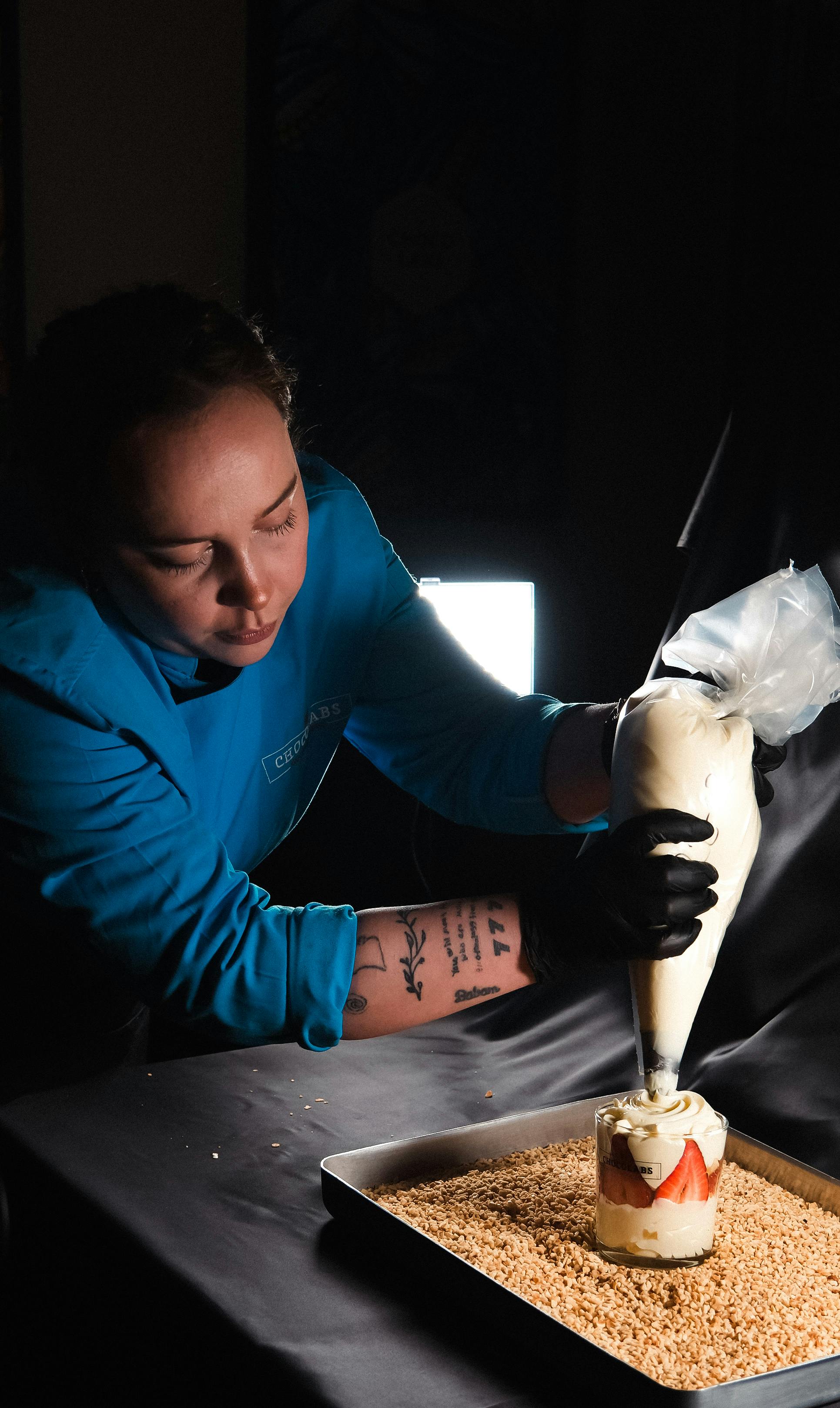 Chef crafting delicious dessert with precision · Free Stock Photo