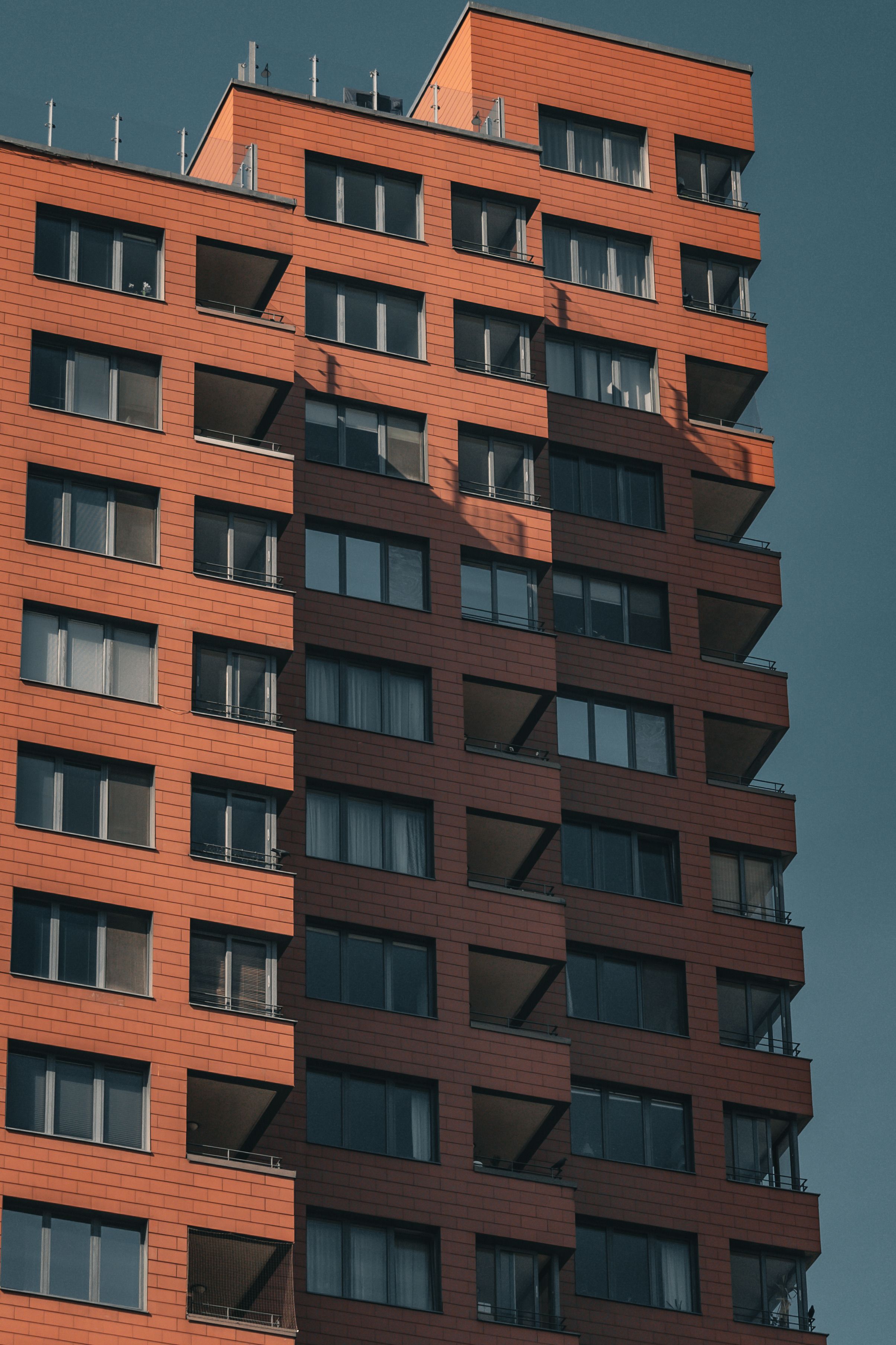 Modern Brick High-Rise Building Against Clear Sky · Free Stock Photo