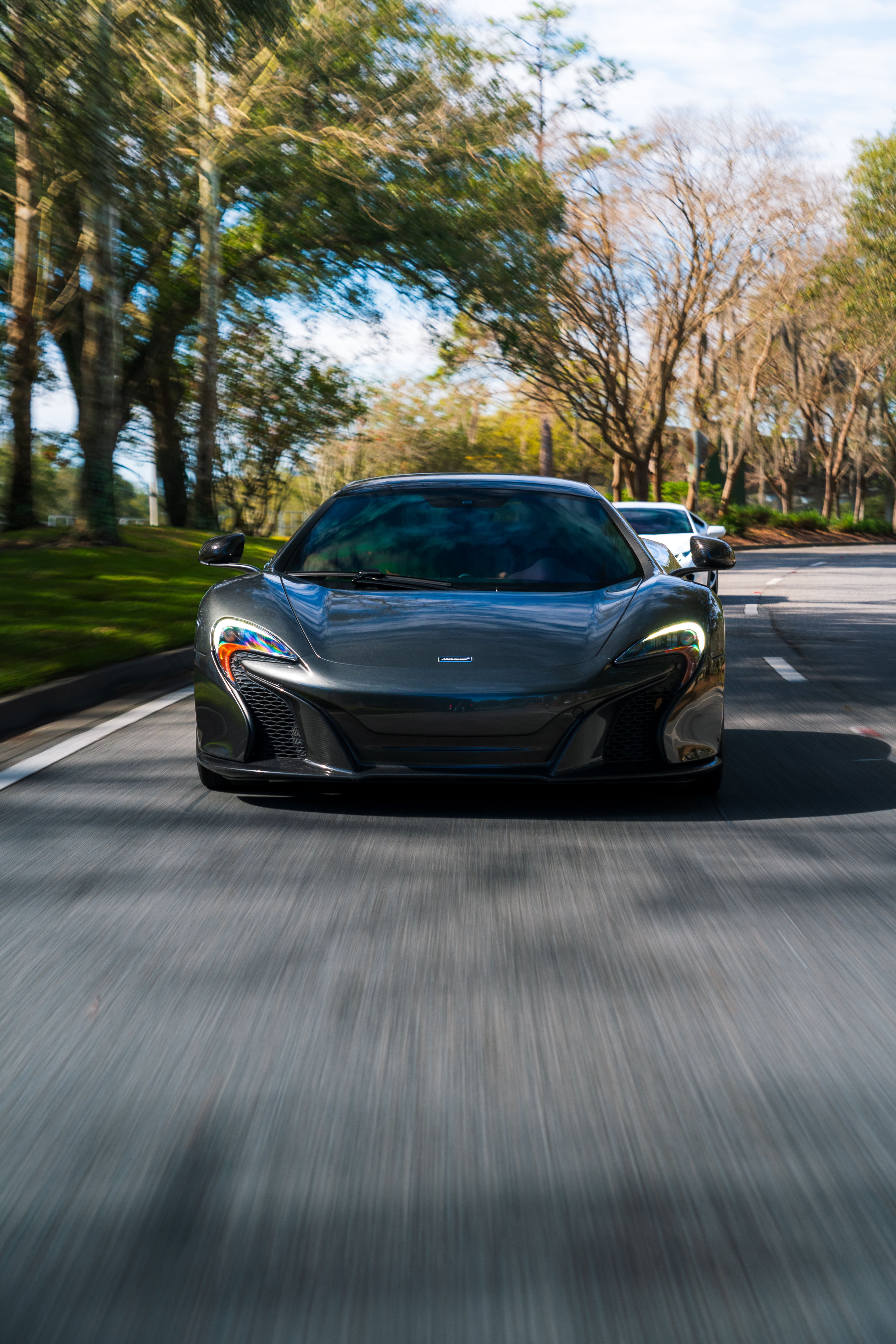 Sleek Grey Sports Car on Scenic Road · Free Stock Photo