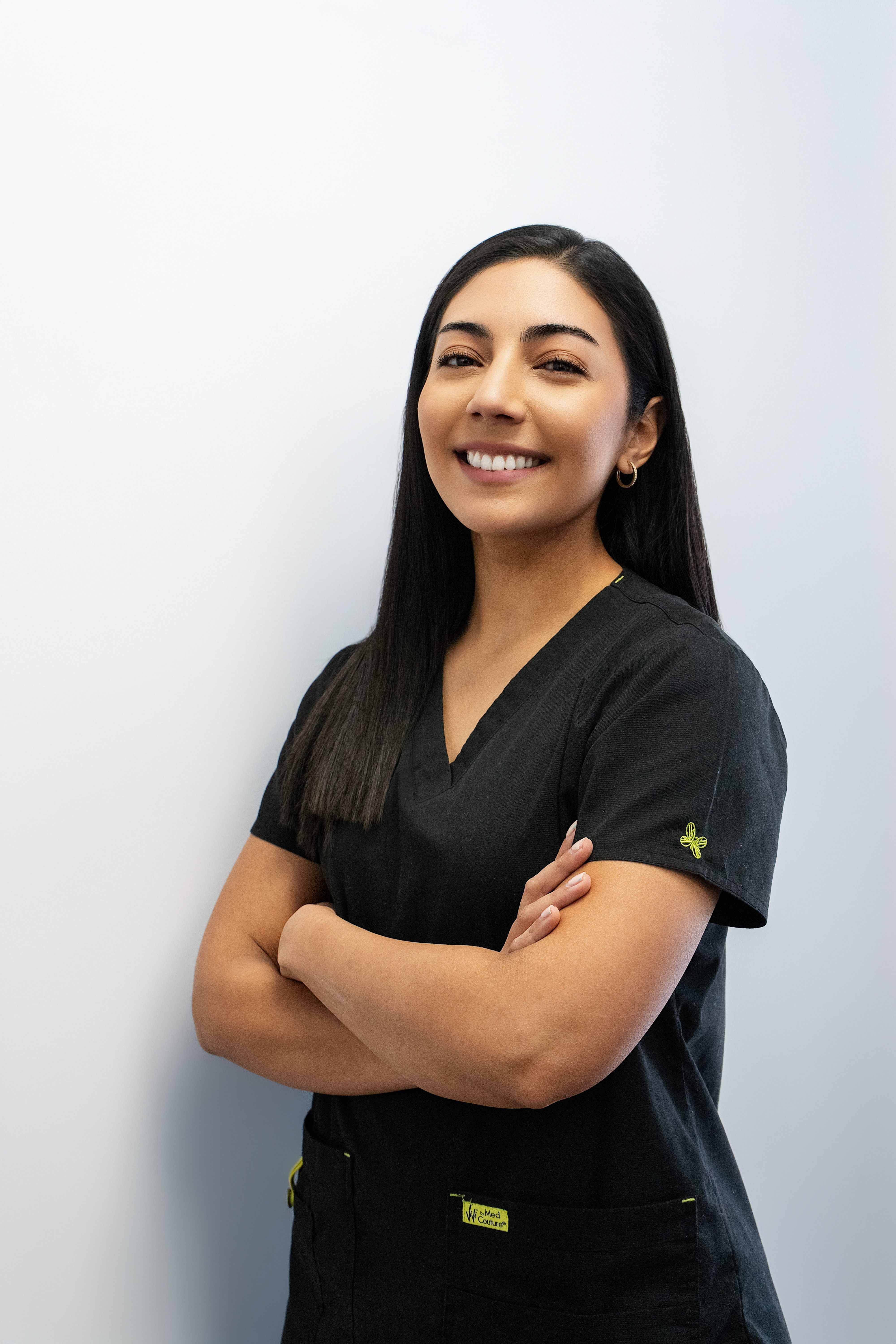 Smiling Female Healthcare Professional with Arms Crossed · Free Stock Photo