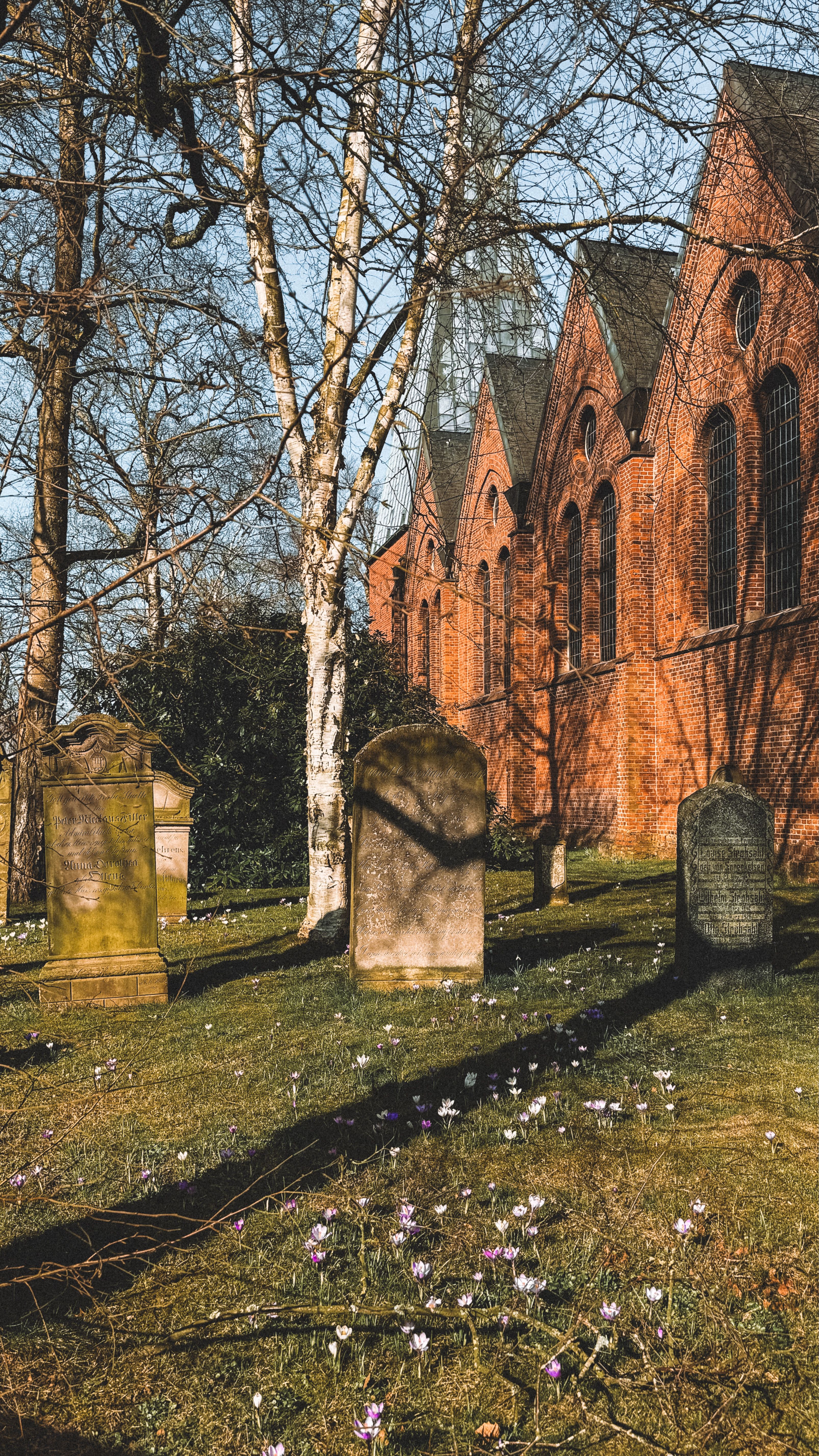 Historic Cemetery Beside Brick Church in Spring · Free Stock Photo