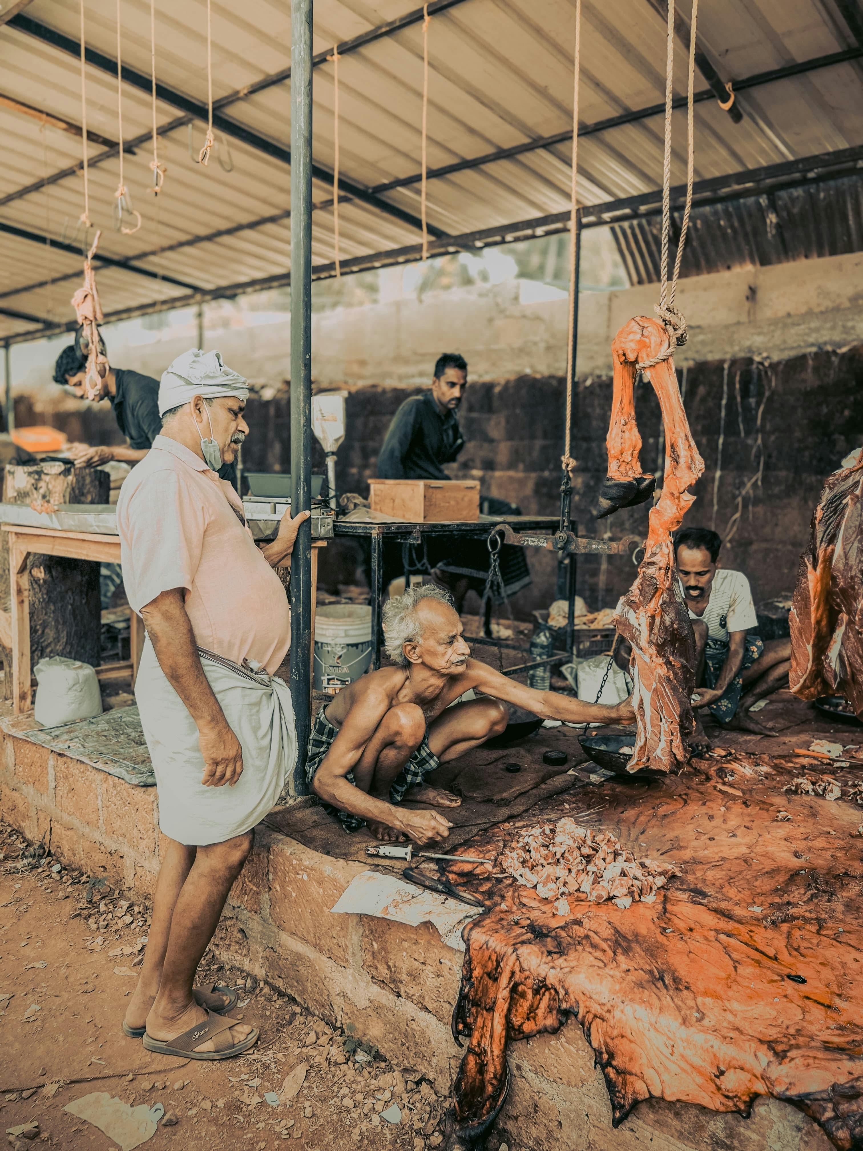 Traditional Butchery Scene with Meat Processing · Free Stock Photo