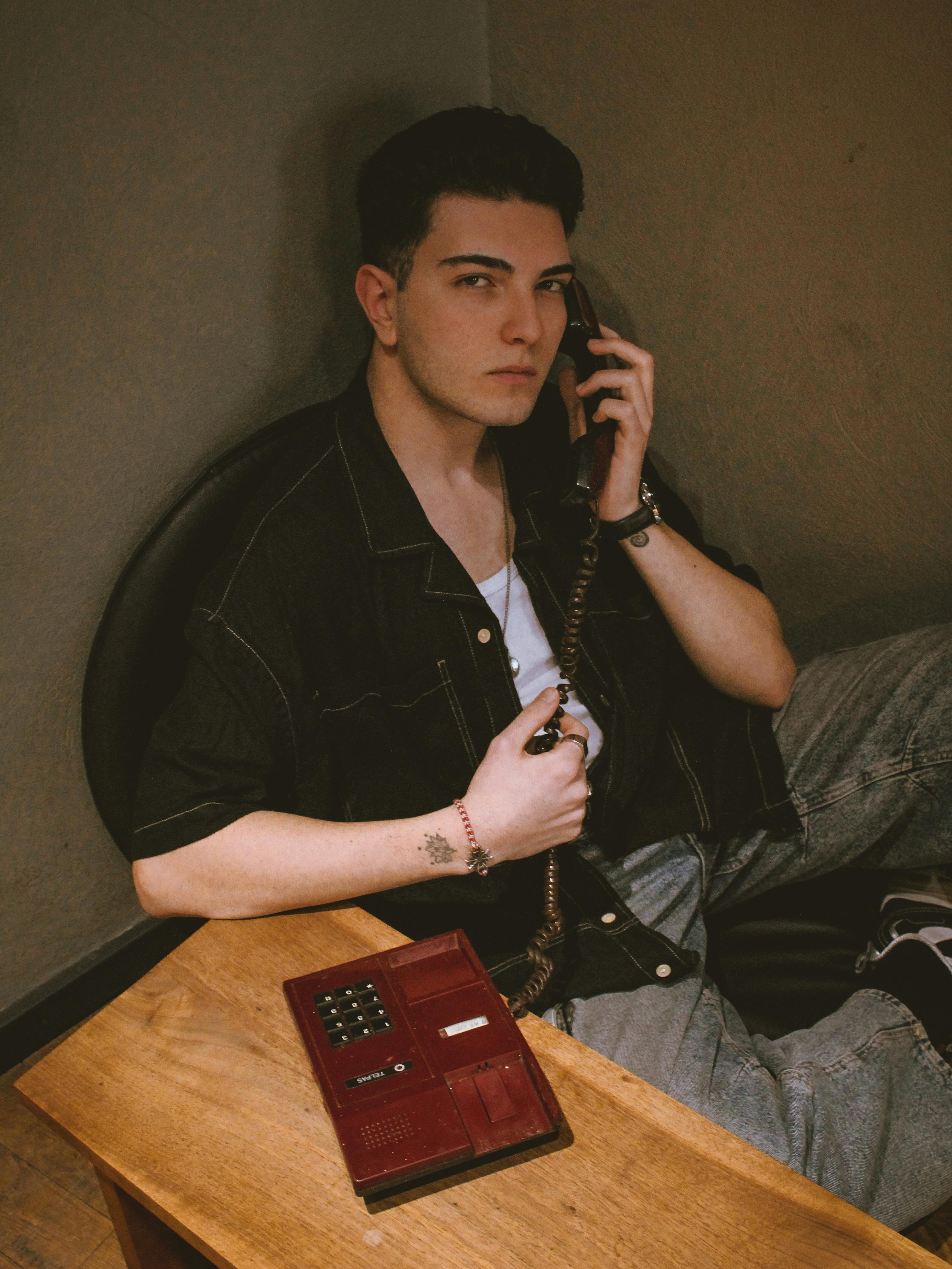 Young Man on Vintage Phone Call Indoors · Free Stock Photo