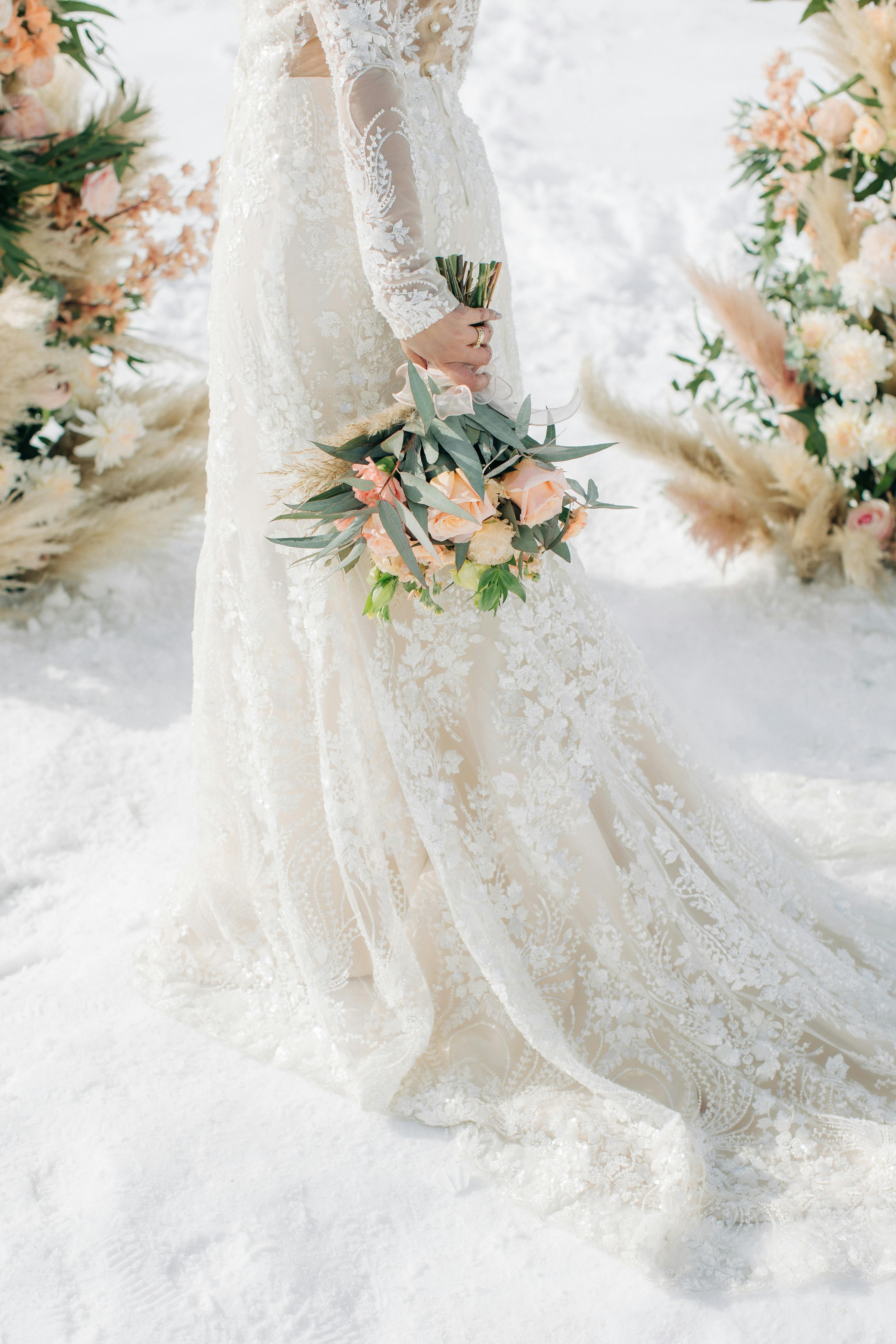 Elegant Bridal Gown in Winter Snow Setting · Free Stock Photo
