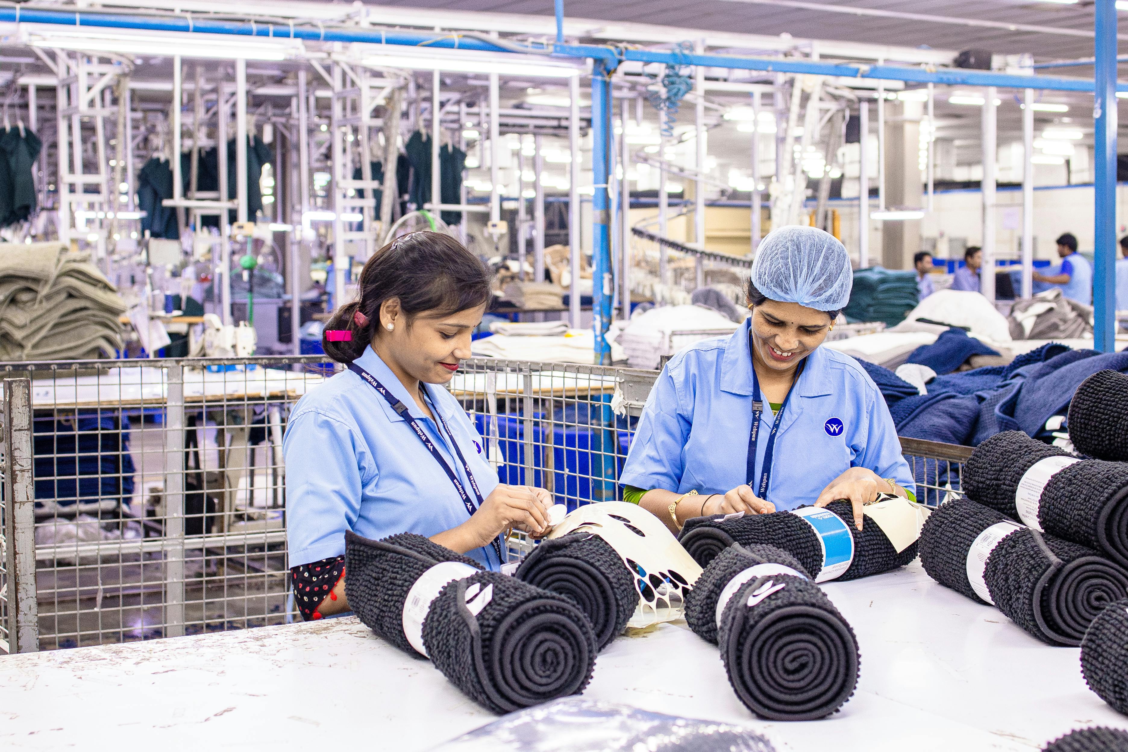 Female Workers in Textile Factory Rolling Fabrics · Free Stock Photo