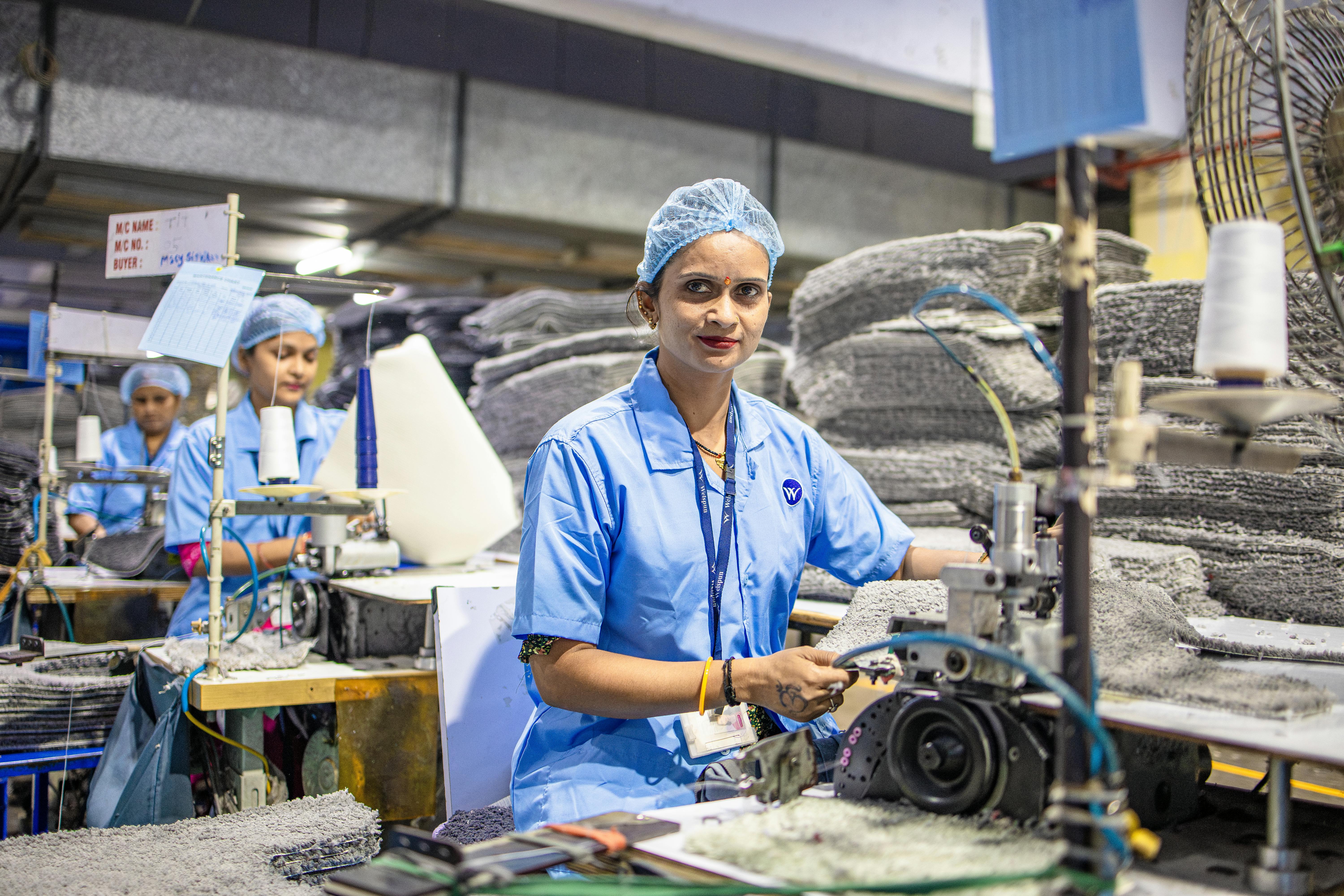 Female Textile Worker Operating Sewing Machine in Factory · Free Stock ...