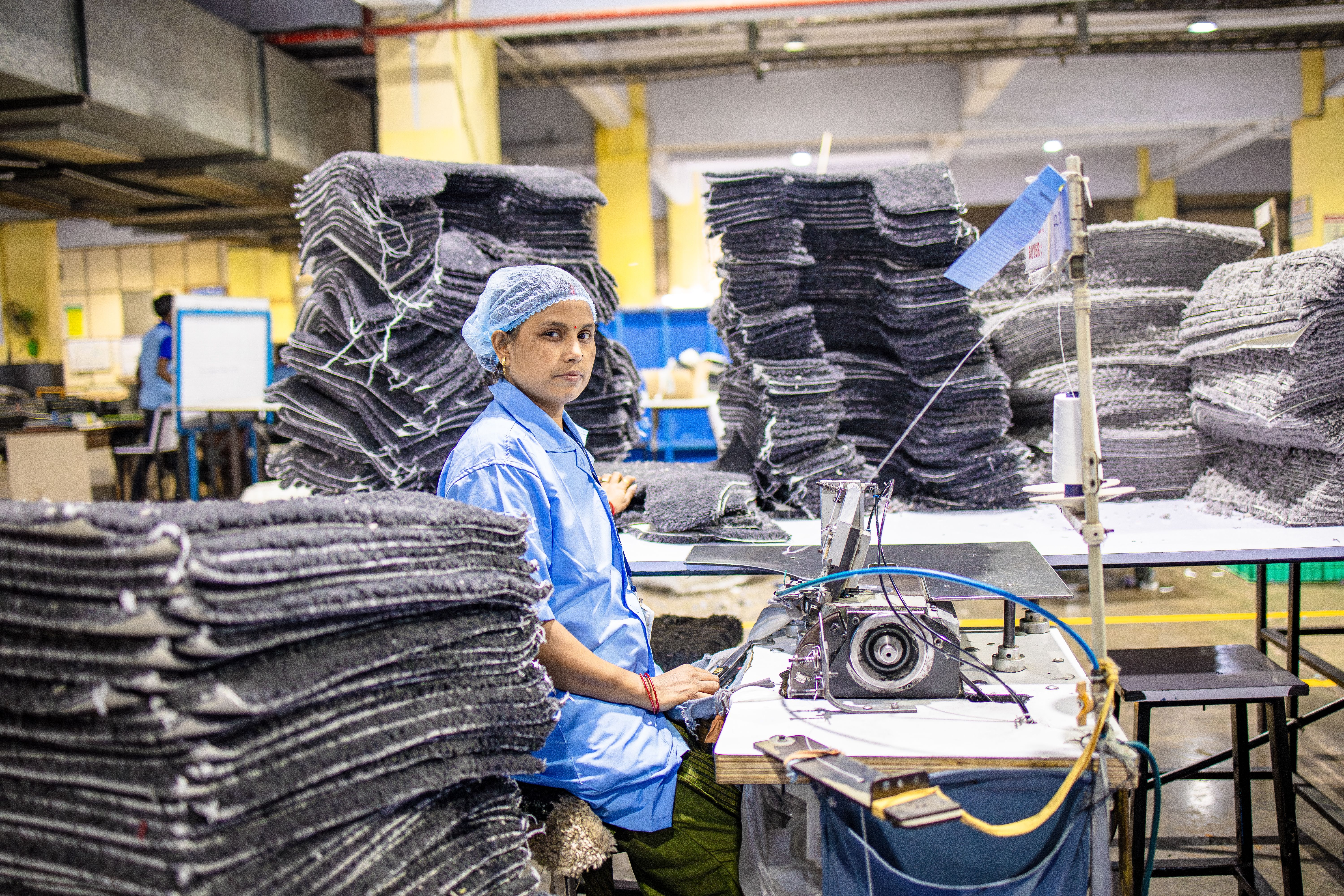 Factory Worker Operating Textile Sewing Machine · Free Stock Photo