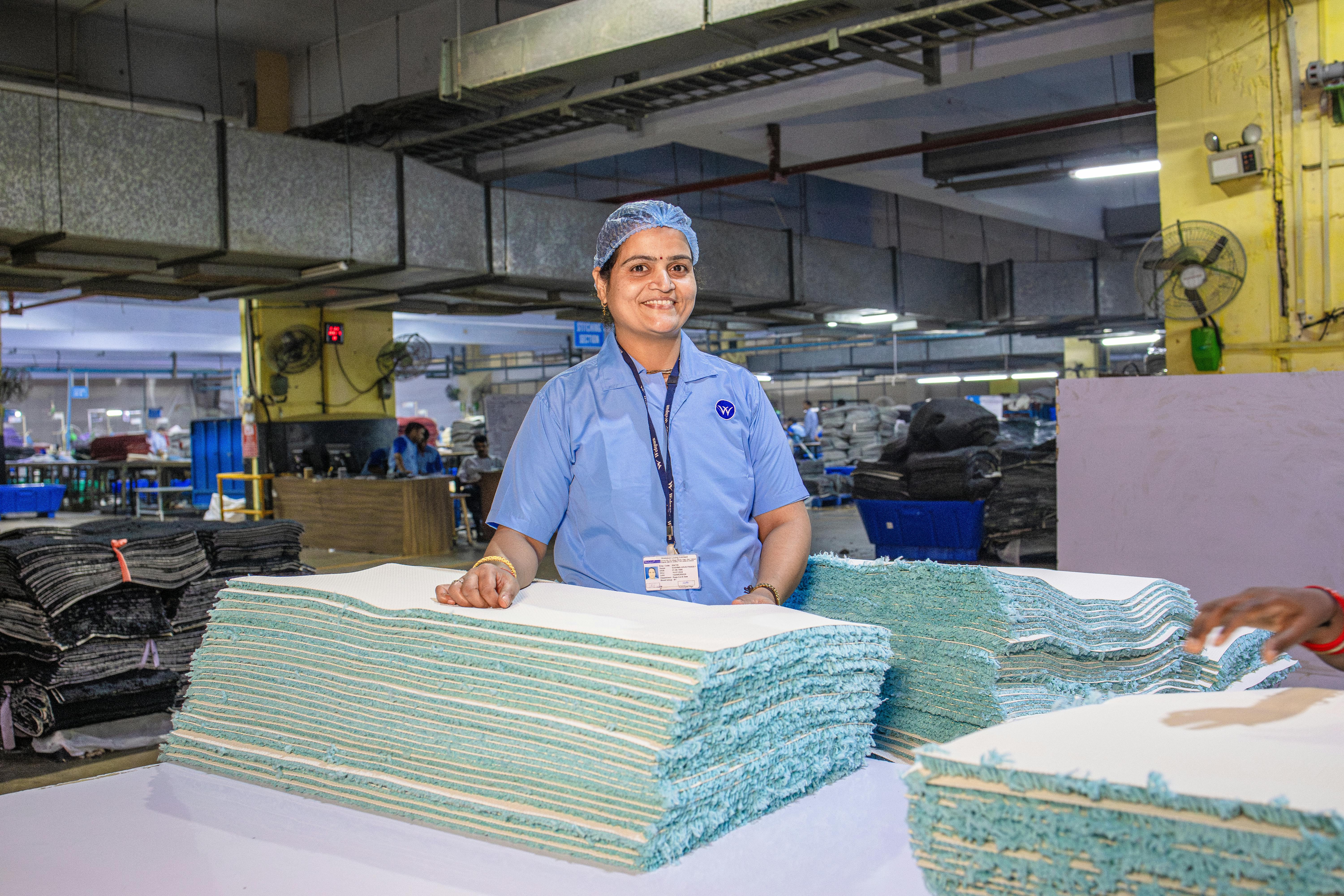 Smiling Factory Worker in Textile Industry Setting · Free Stock Photo