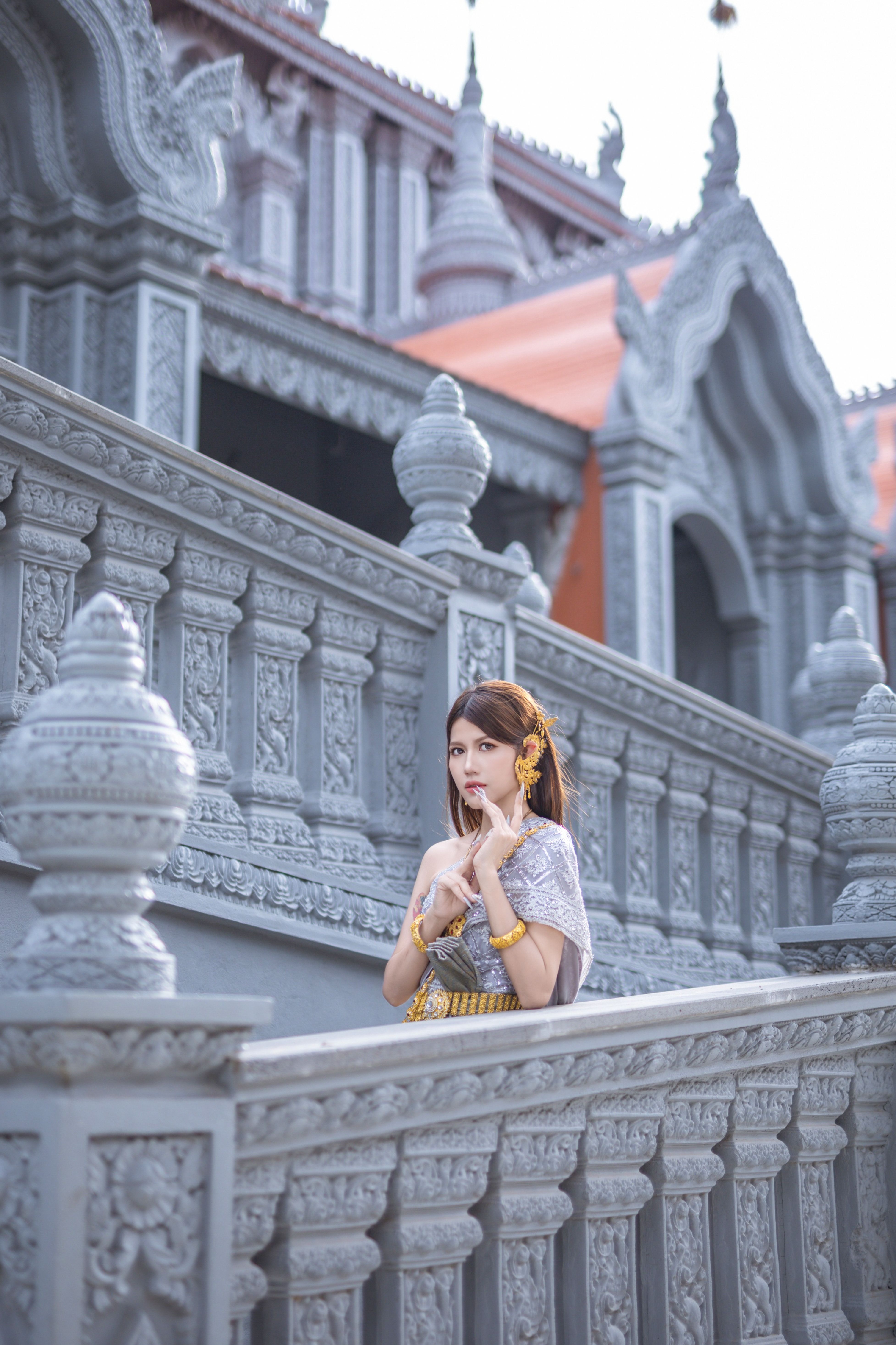Woman in Traditional Dress at Ornate Temple · Free Stock Photo