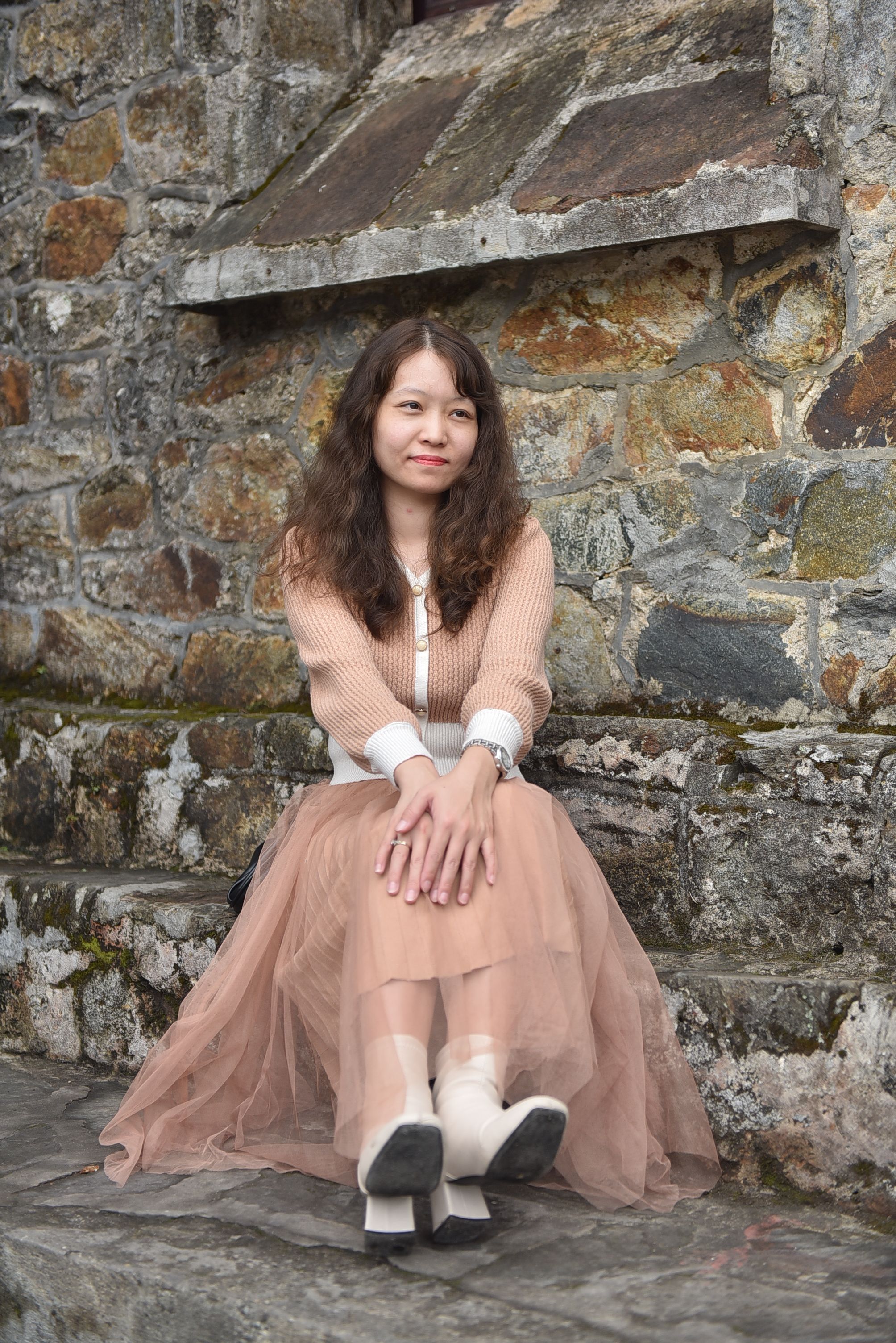 Woman Sitting on Stone Steps in Casual Fashion · Free Stock Photo