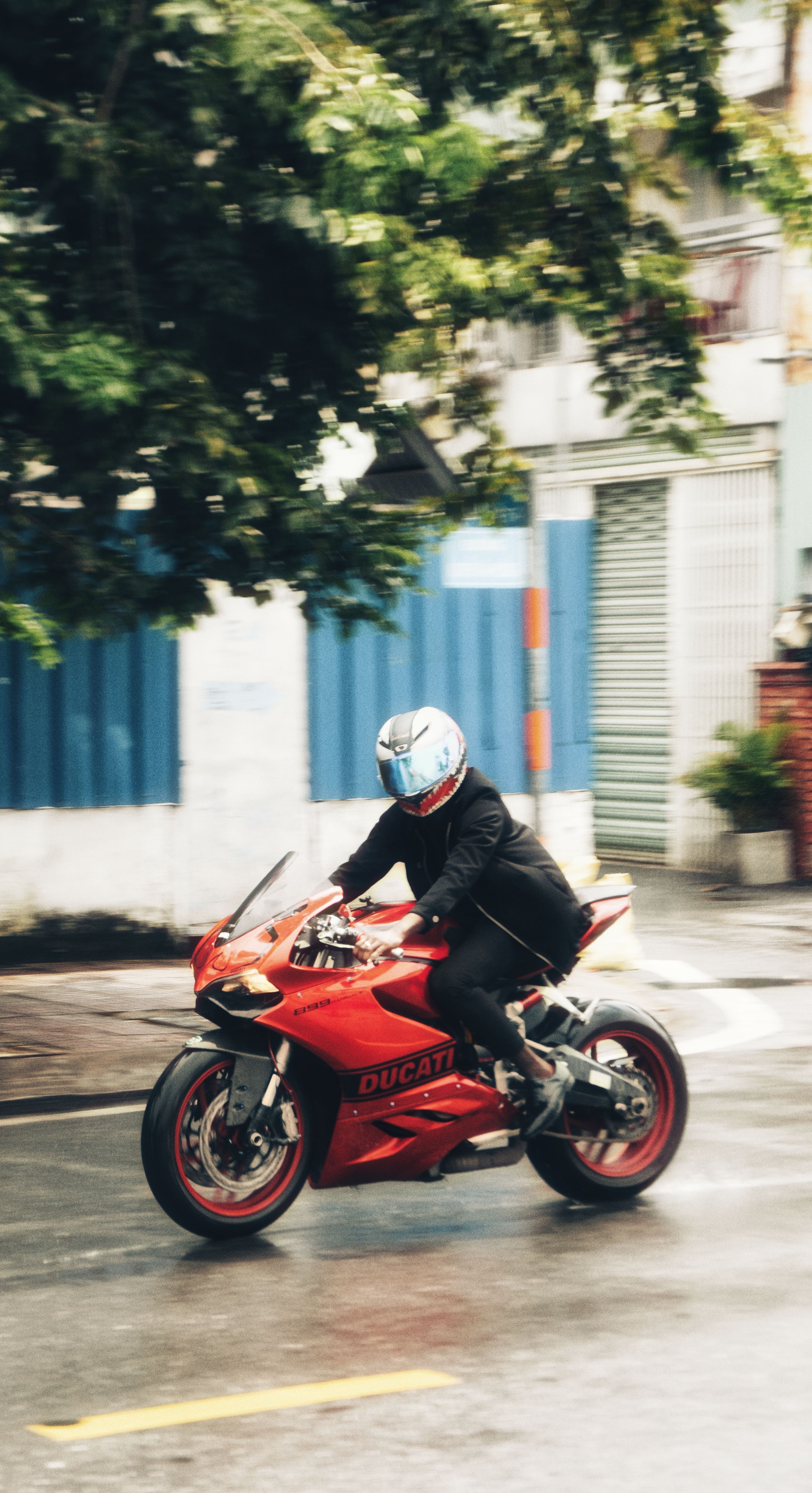 Rider on Red Ducati Sports Motorcycle in Urban Setting · Free Stock Photo