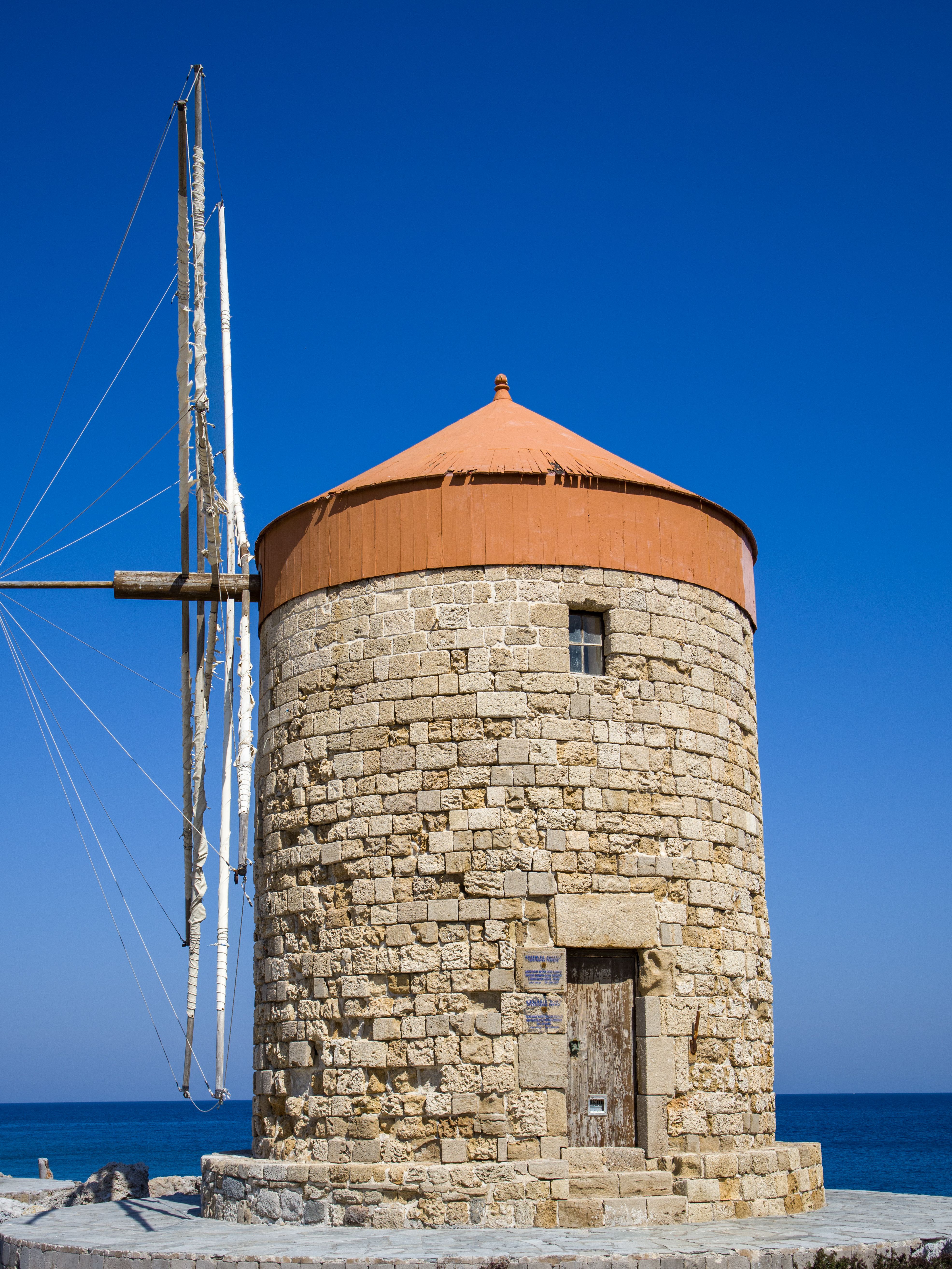 Historic Windmill by the Sea under Clear Sky · Free Stock Photo