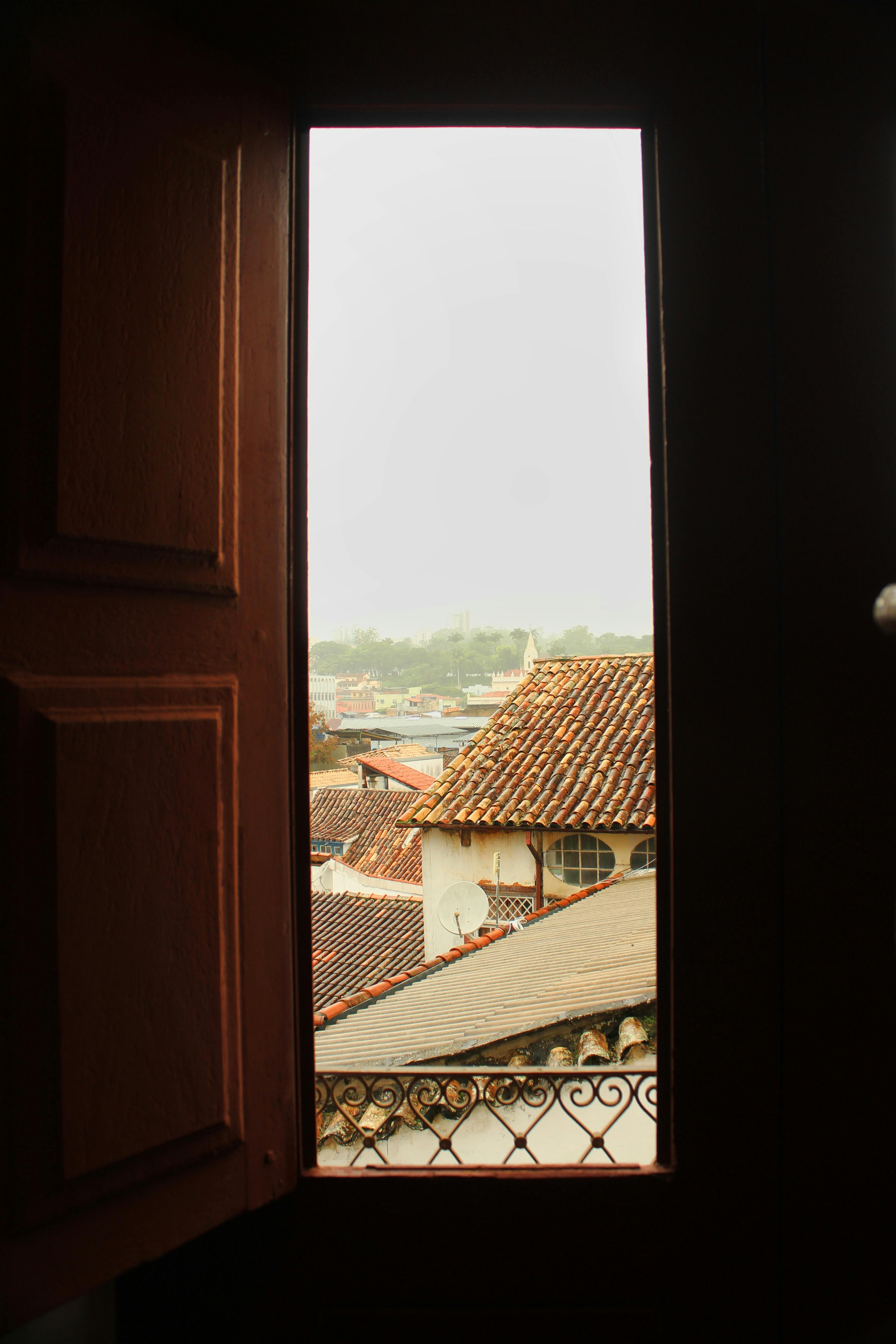 Scenic View of Tiradentes Rooftops through Window · Free Stock Photo