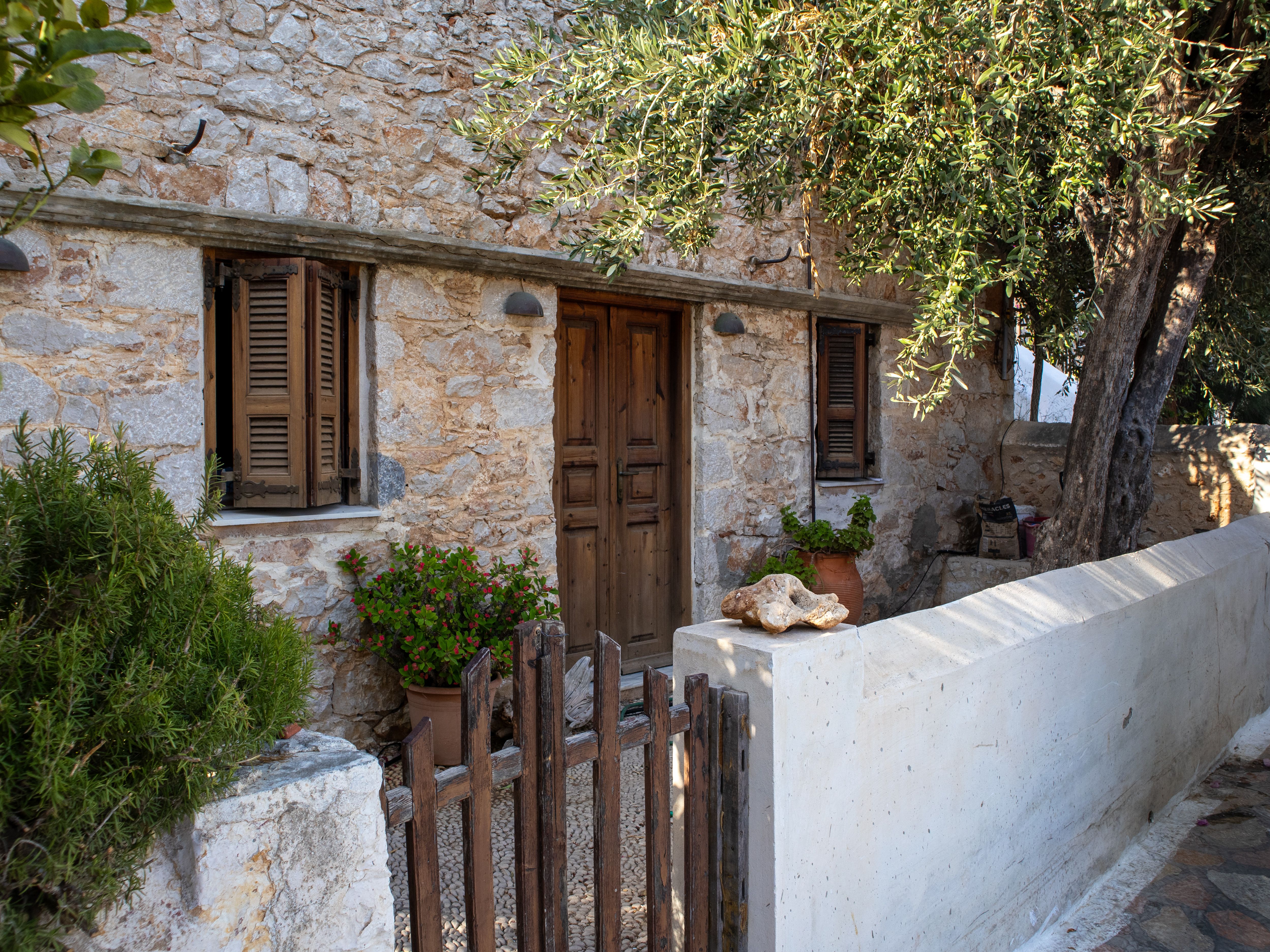 Charming Rustic Stone House with Wooden Shutters · Free Stock Photo
