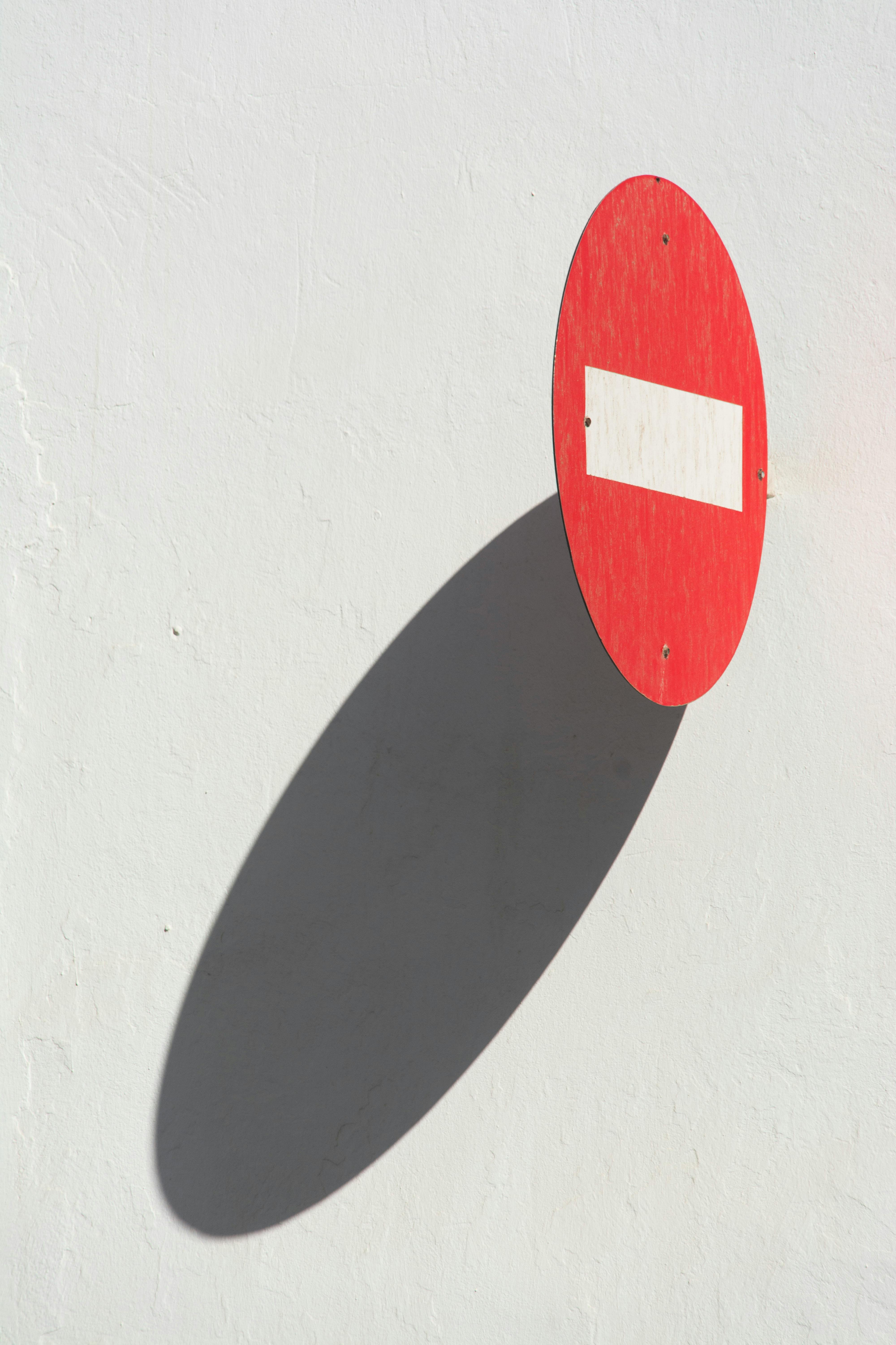 Minimalist Traffic Sign with Shadow on Wall · Free Stock Photo