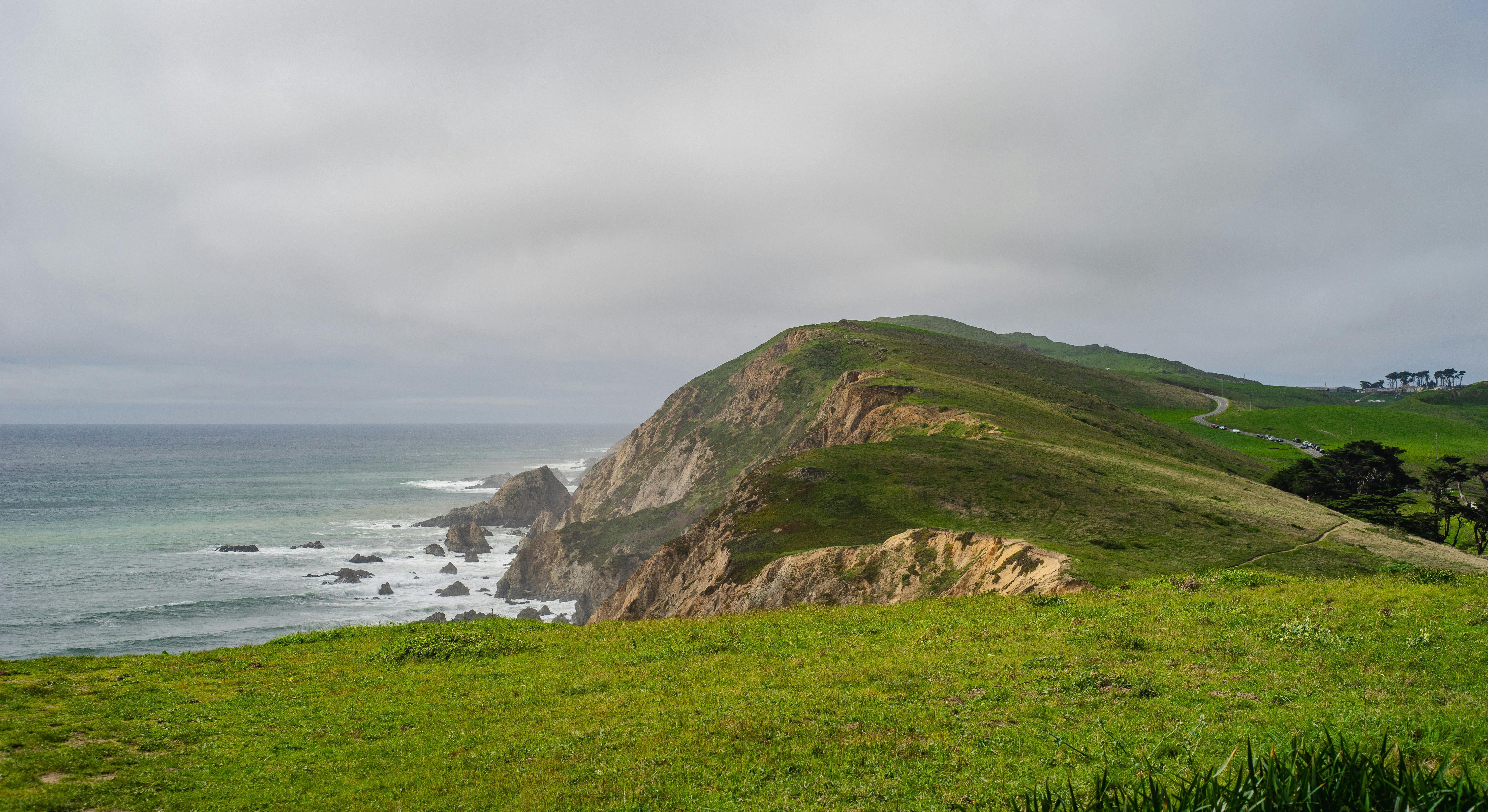 Scenic Coastal Cliffside with Green Fields · Free Stock Photo