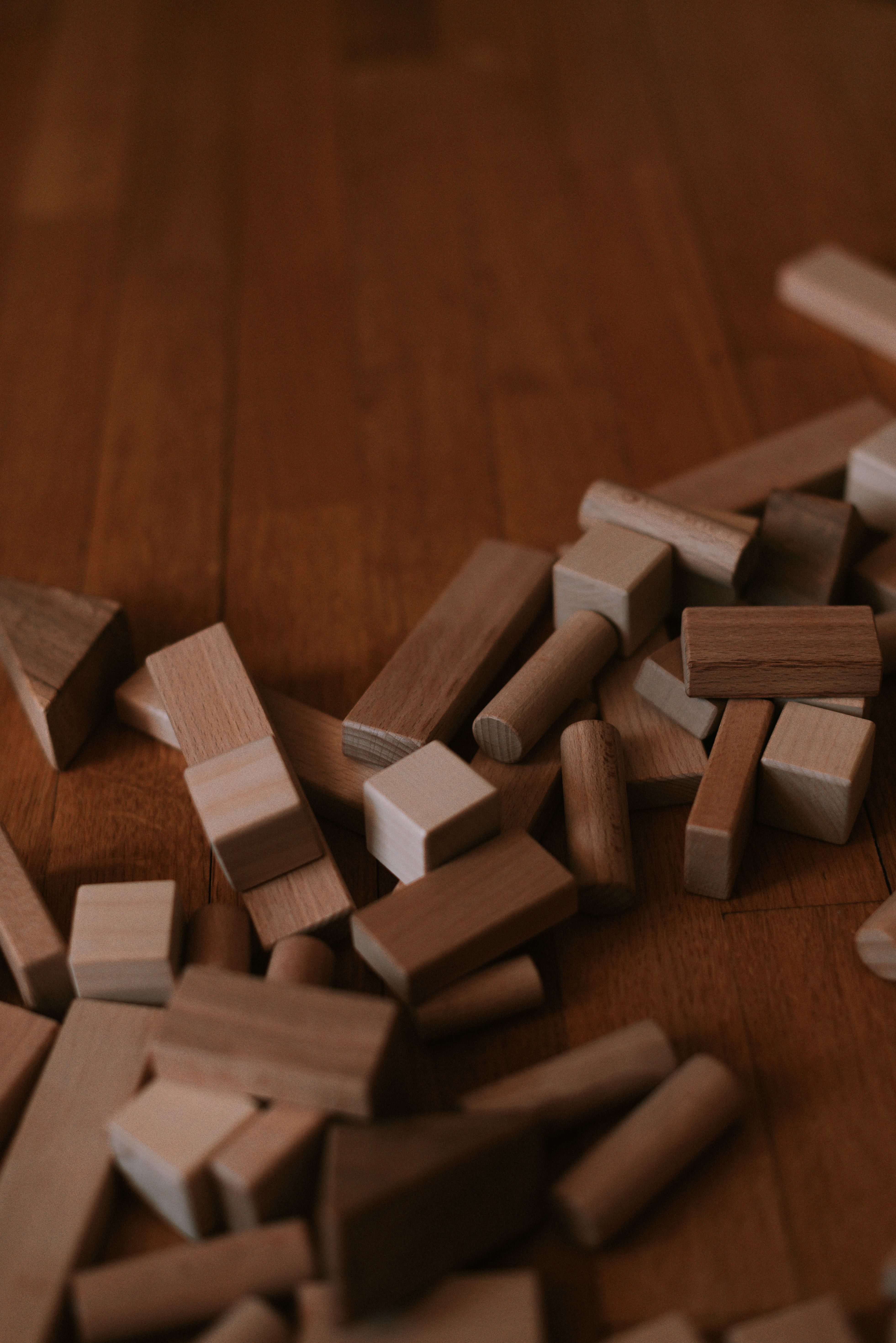 Scattered Wooden Building Blocks on Wooden Floor · Free Stock Photo