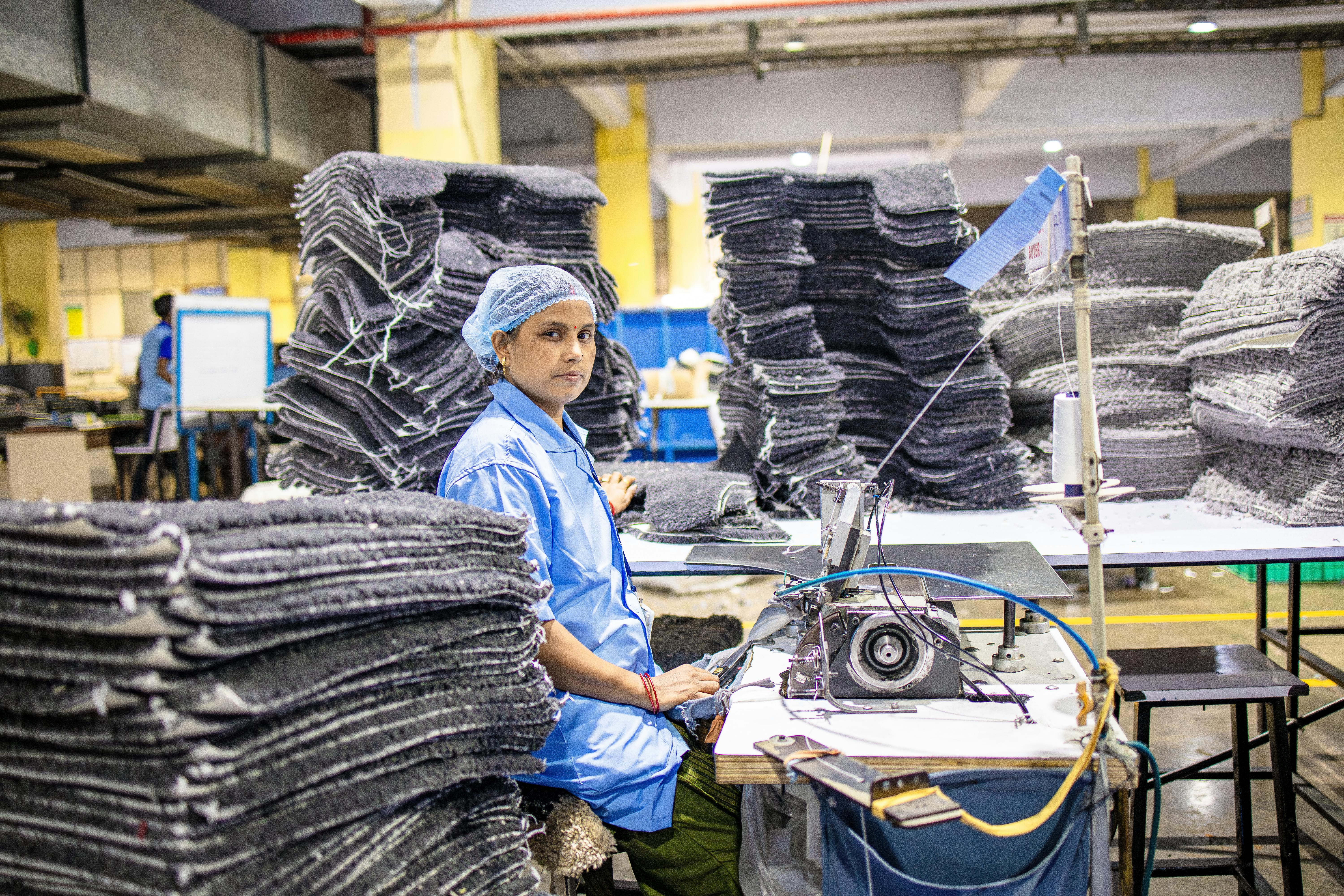 Textile Factory Worker Operating Sewing Machine · Free Stock Photo