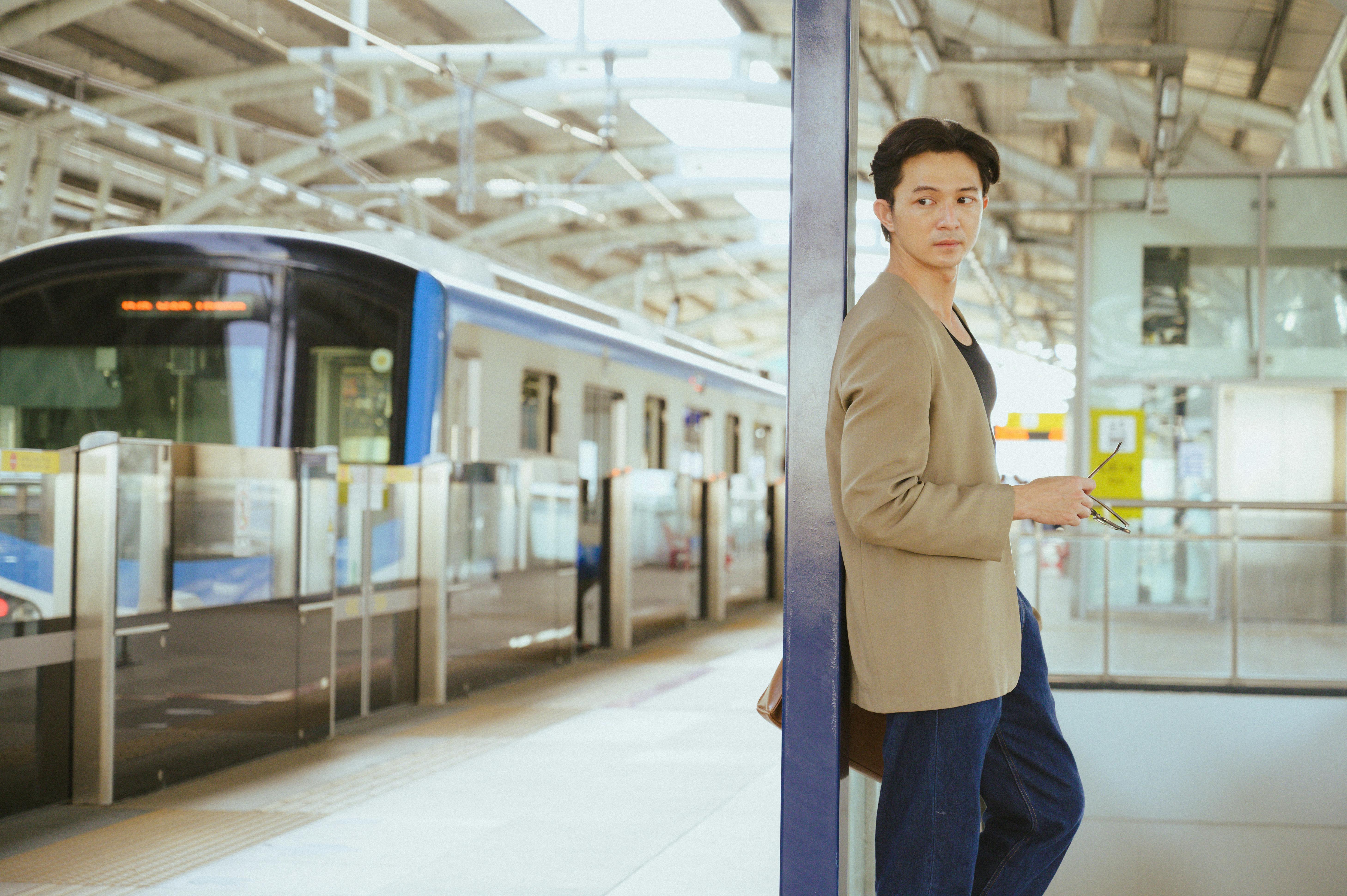 Young man waiting at modern train station · Free Stock Photo
