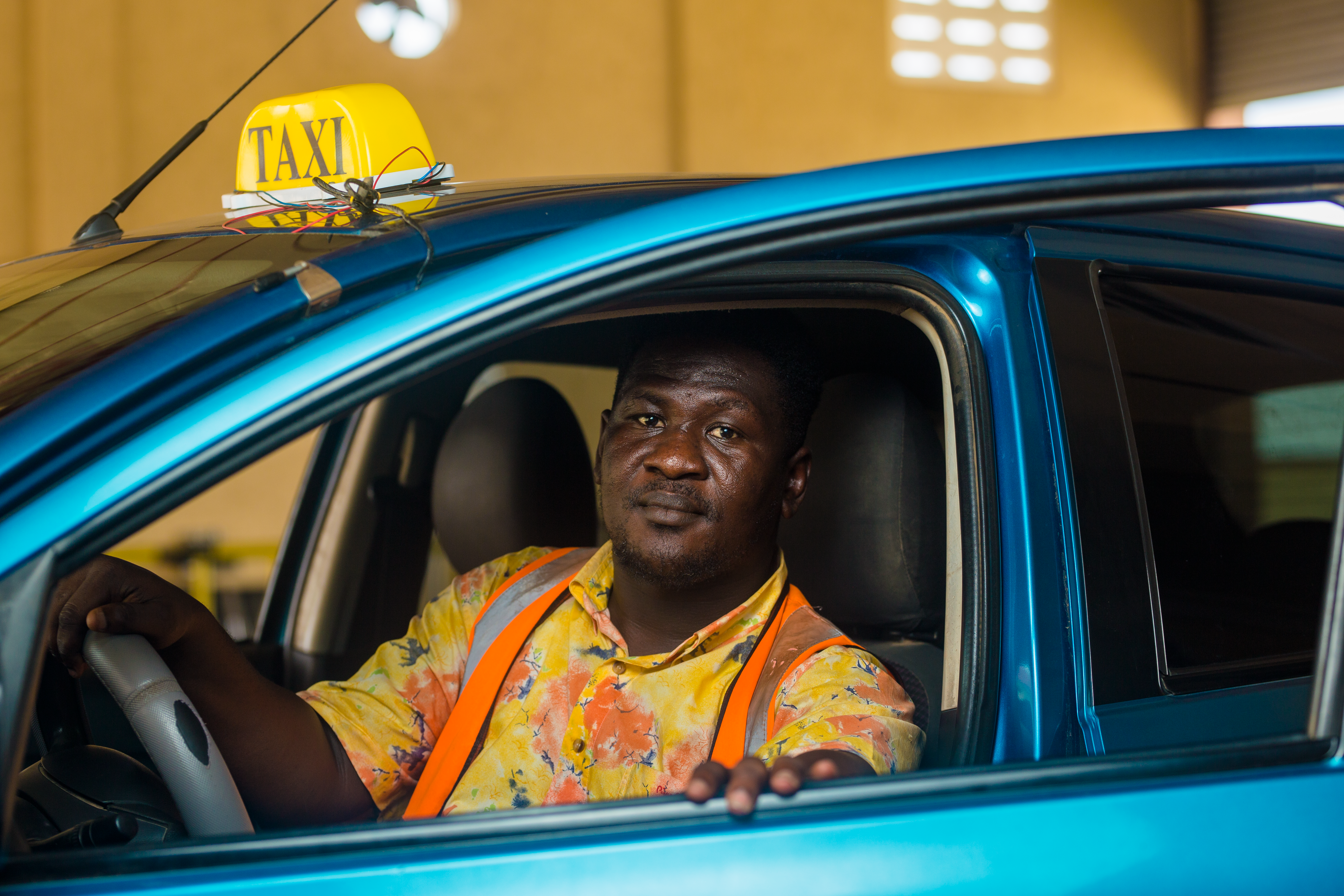 Portrait of a Ghanaian Taxi Driver Inside Vehicle · Free Stock Photo