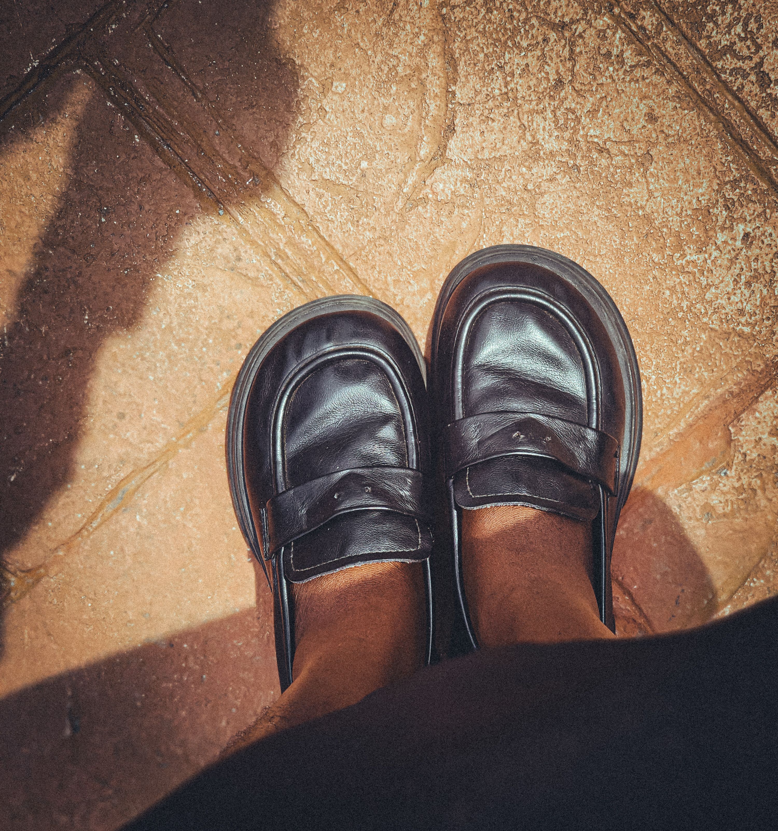 Top View of Black Loafers on Brick Pavement · Free Stock Photo