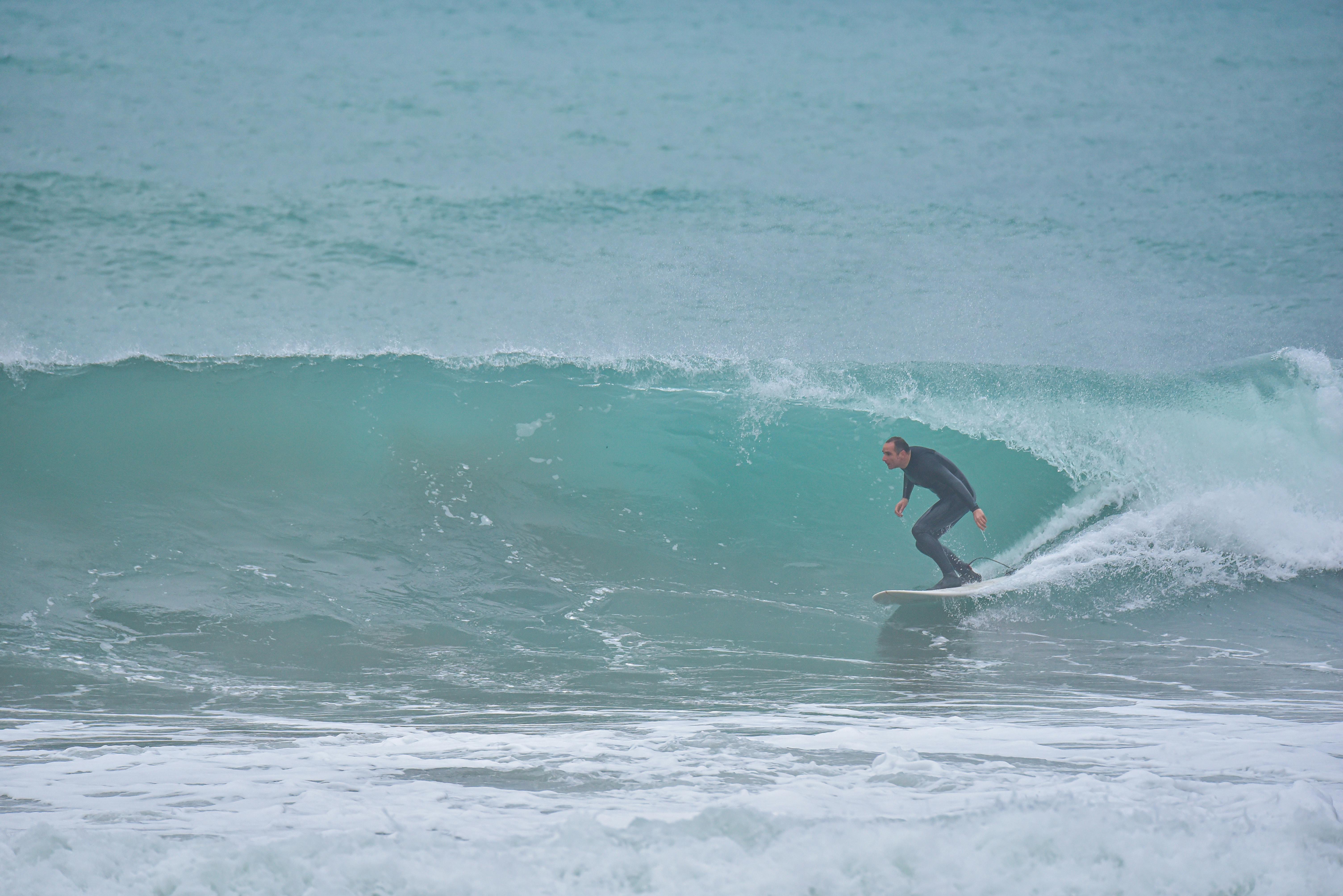 Man Surfing Inside a Curling Ocean Wave · Free Stock Photo