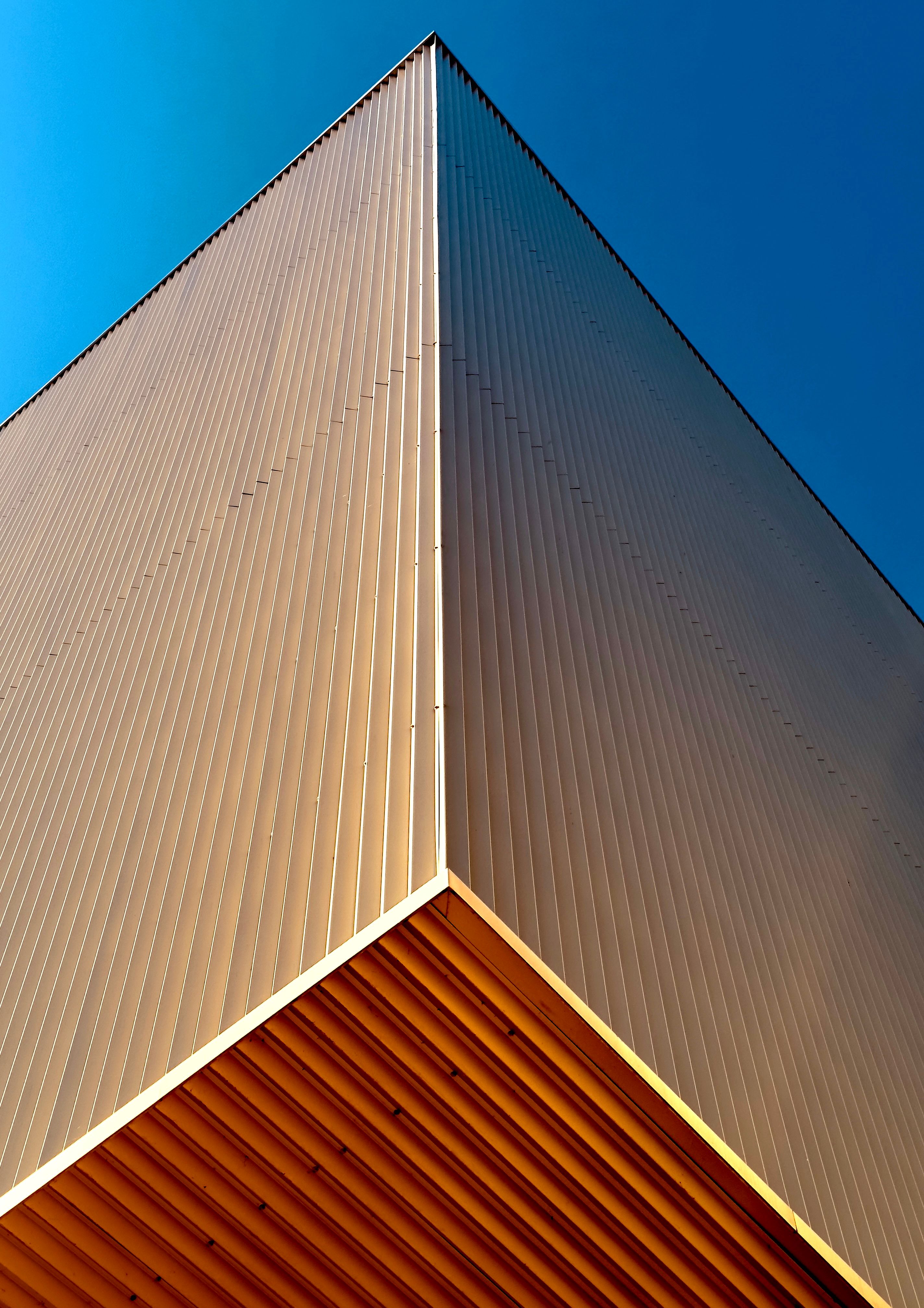 Modern Architectural Corner with Blue Sky Background · Free Stock Photo