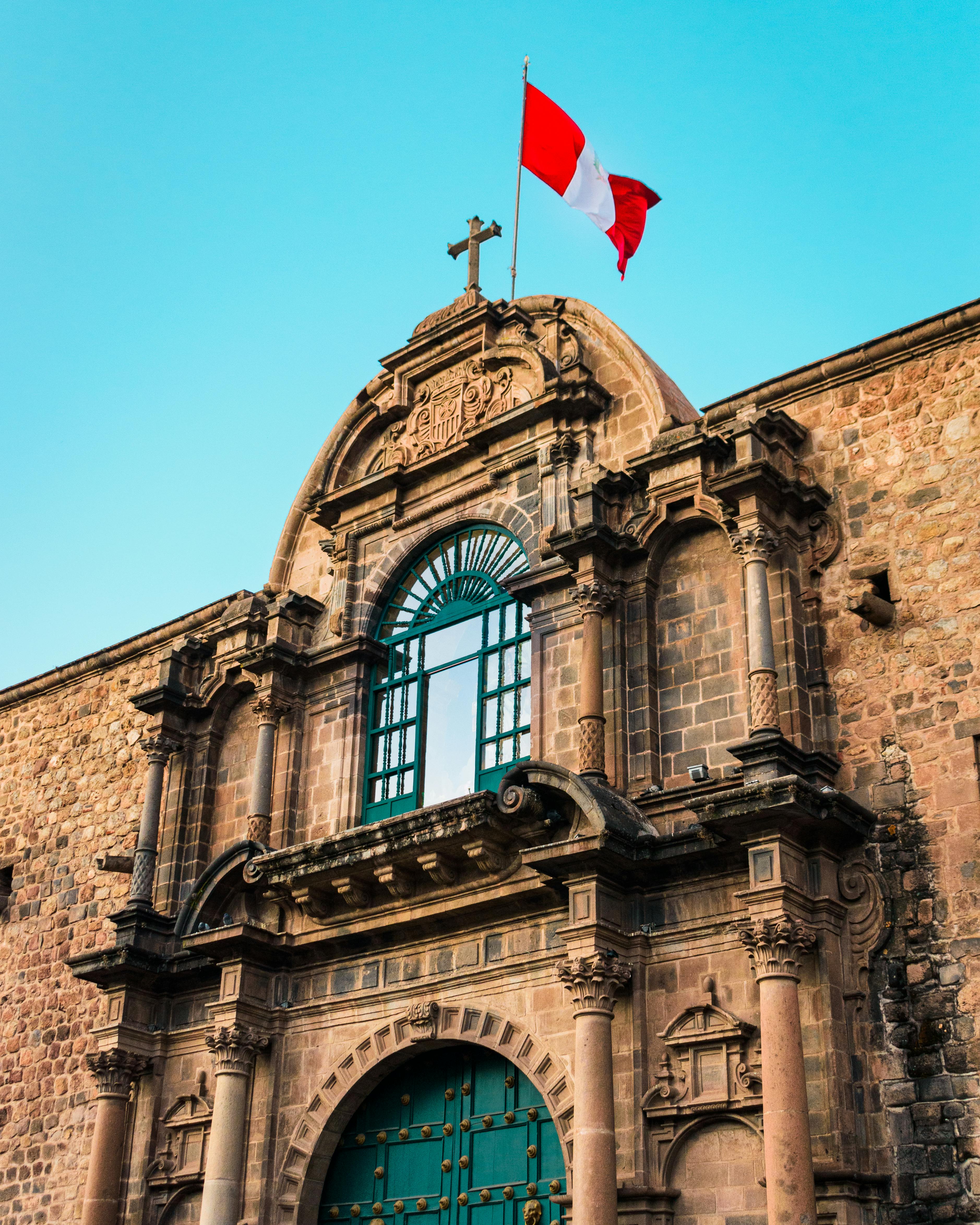 Historical Architecture in Cusco with Peruvian Flag · Free Stock Photo