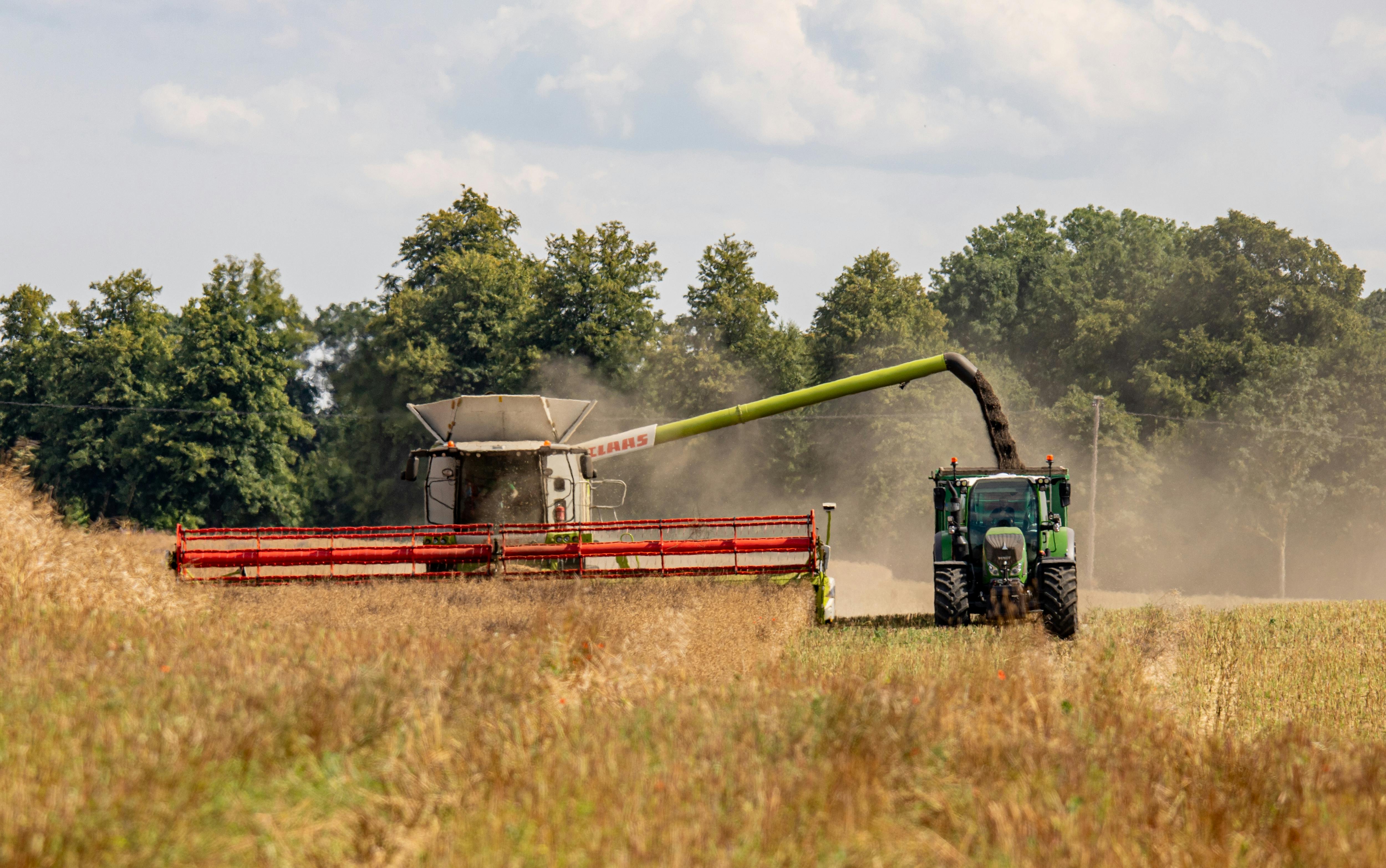 Combine Harvester in Action in German Crop Field · Free Stock Photo