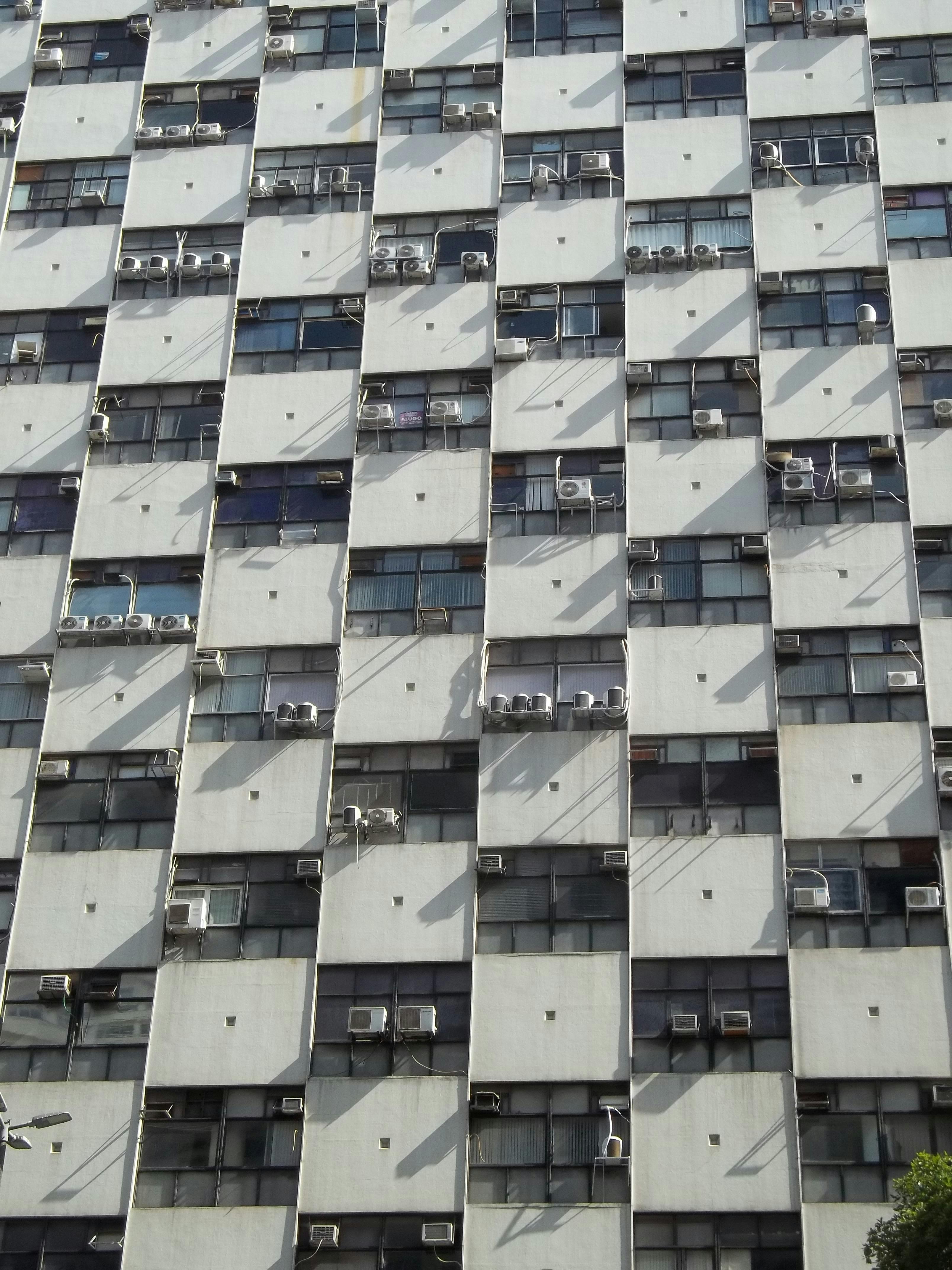 High-Rise Building Facade with Air Conditioners · Free Stock Photo