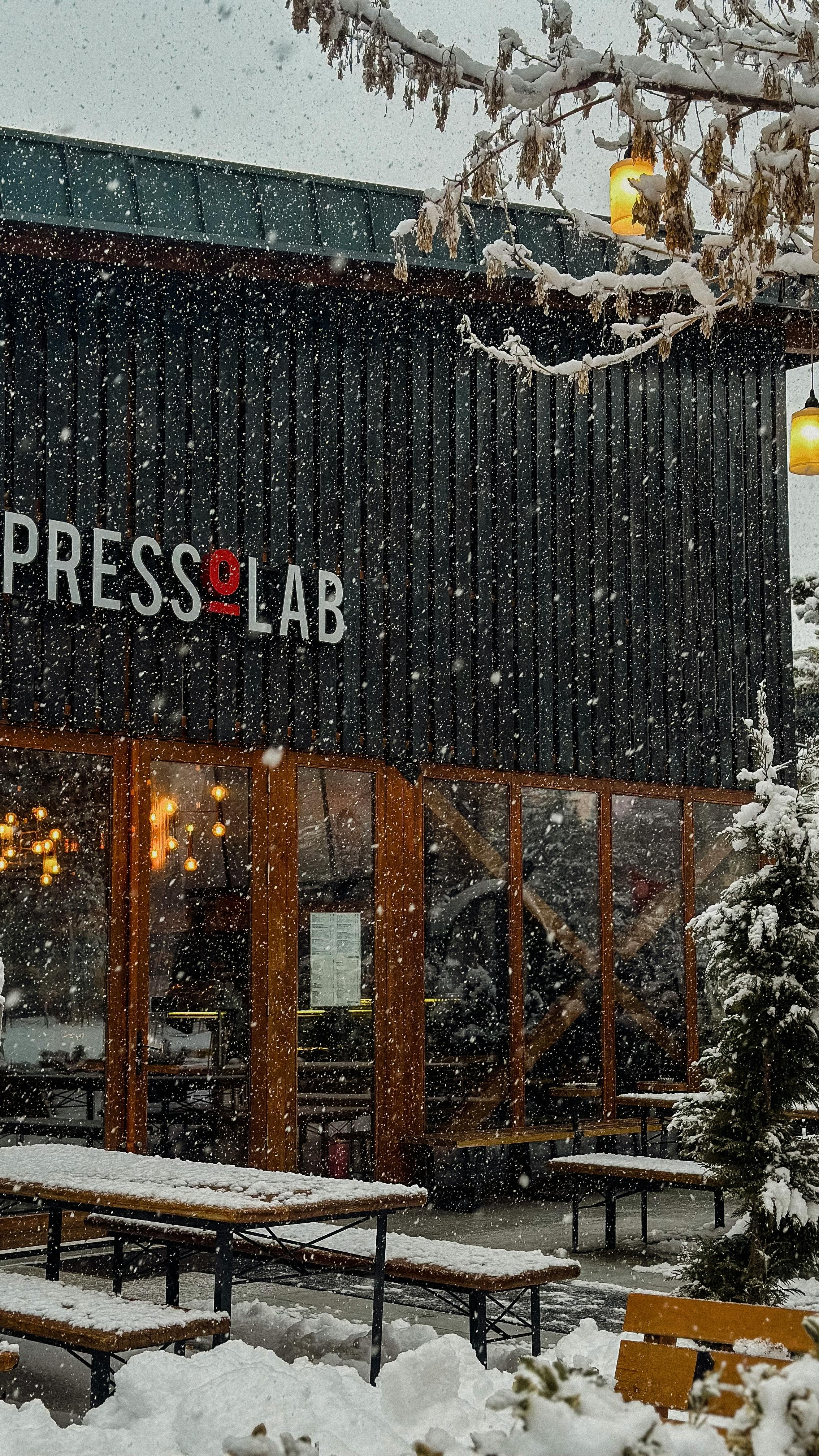 Snowy Café Exterior with Winter Ambiance · Free Stock Photo