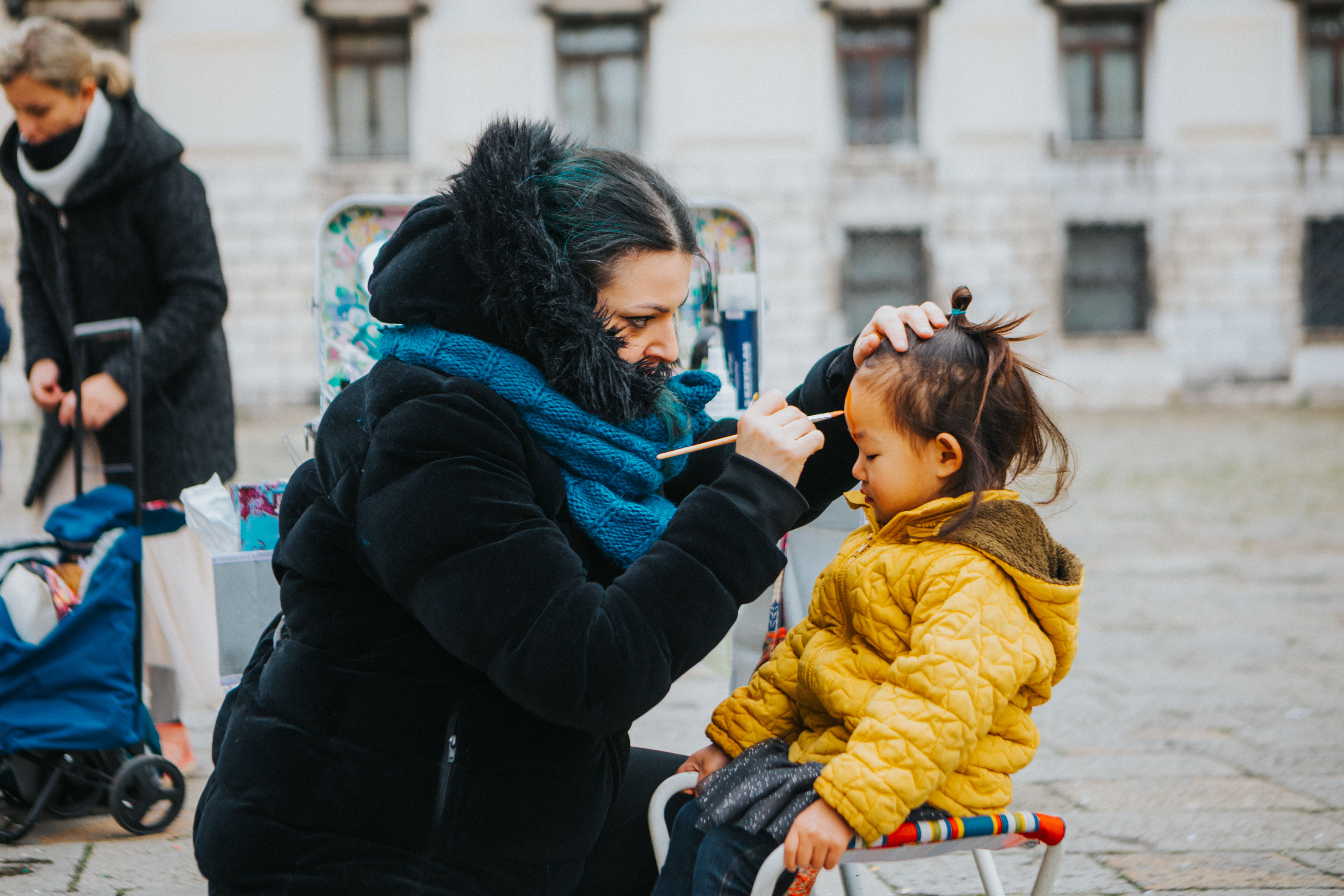 Face Painting Outdoors with Child in Winter · Free Stock Photo