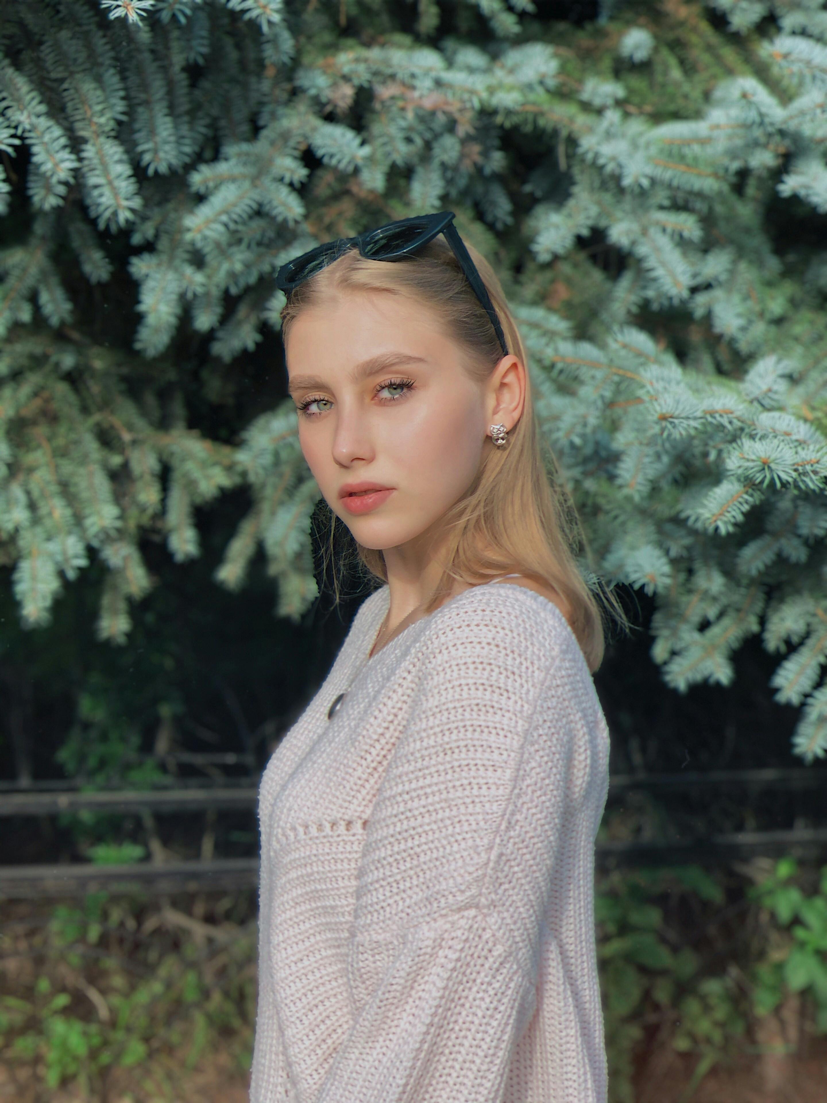 Young Woman in Nature with Fir Tree Background · Free Stock Photo