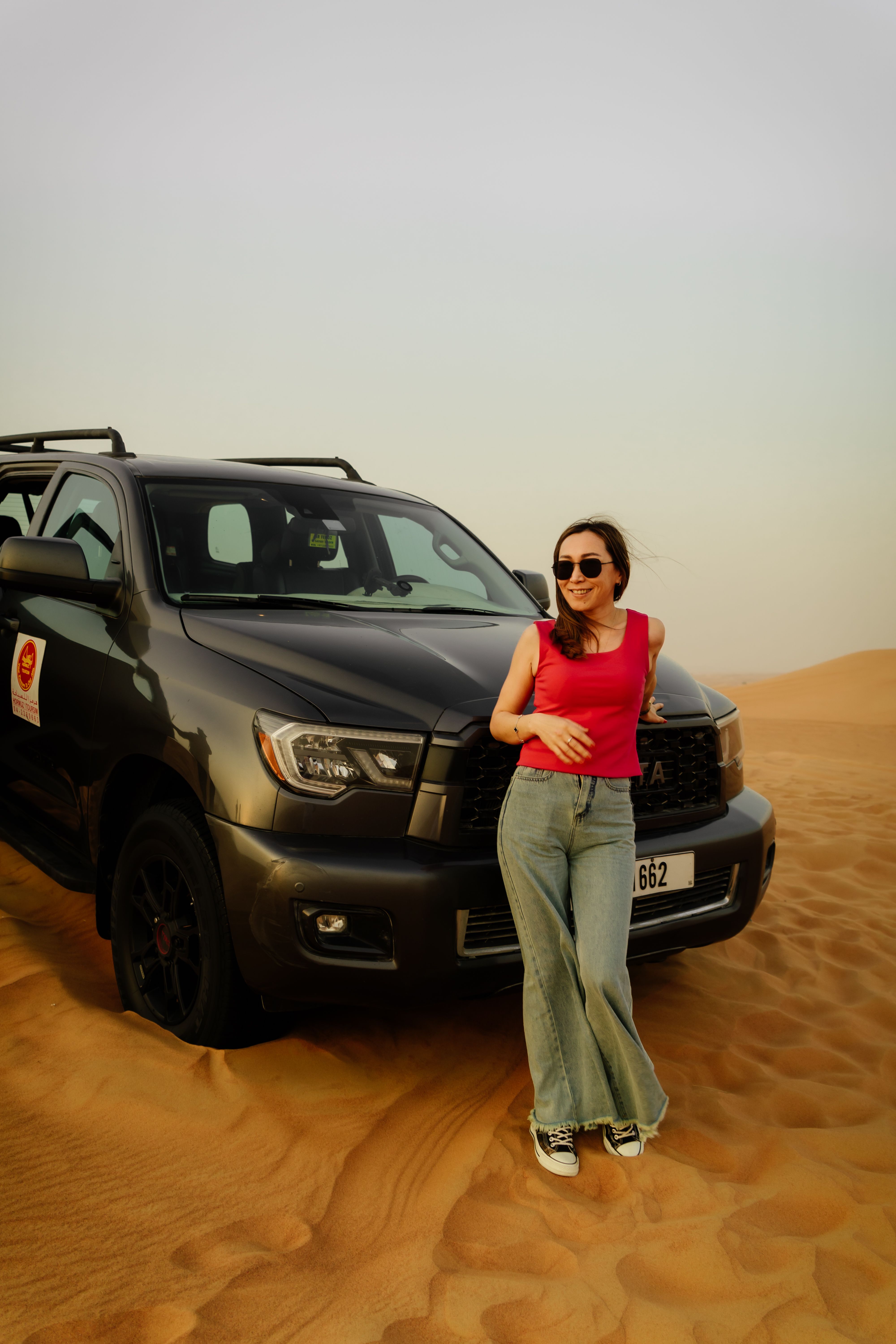 Woman Posing with SUV in Sandy Desert Landscape · Free Stock Photo