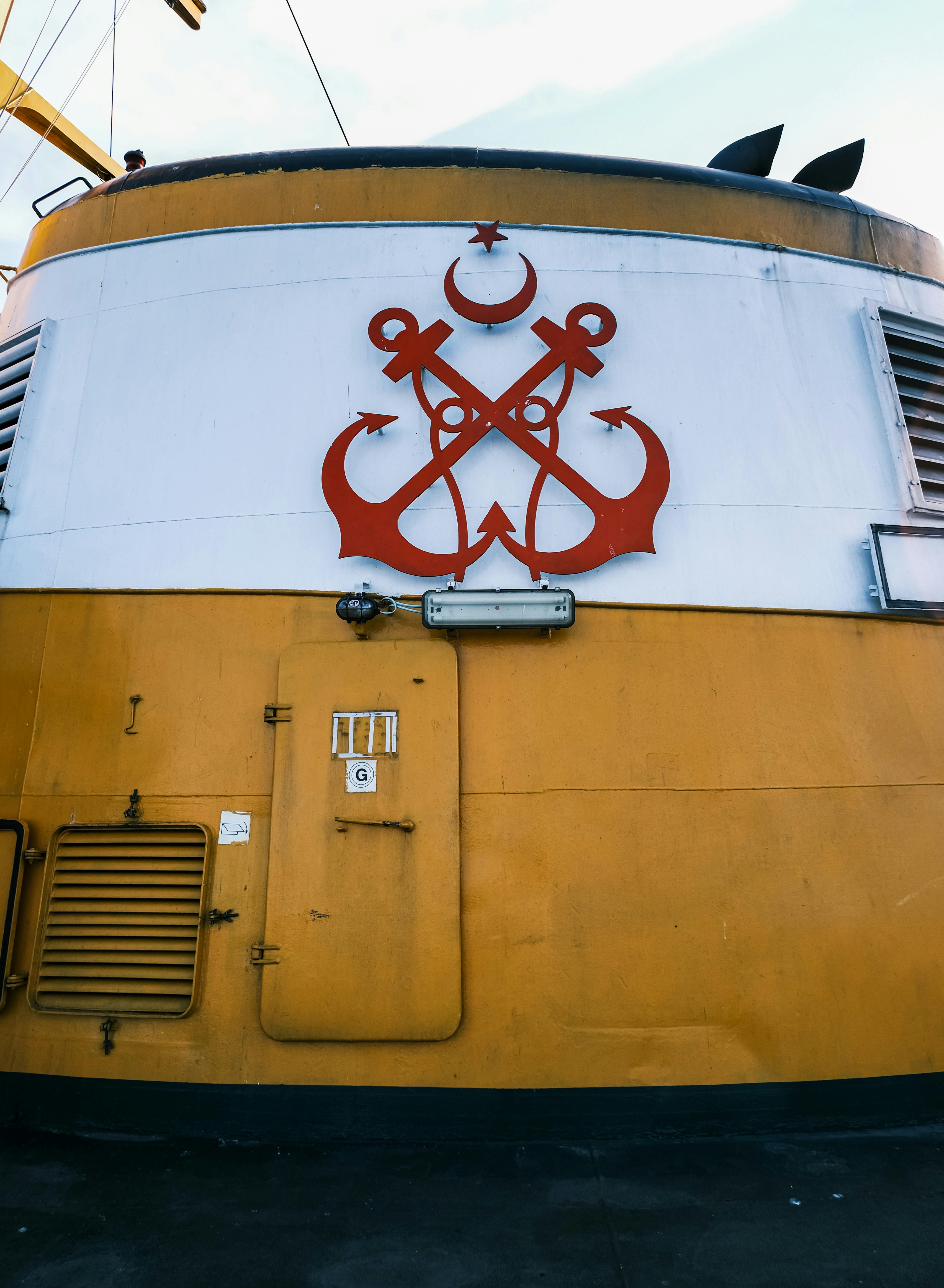 Nautical Symbol on Yellow Ship Hull · Free Stock Photo
