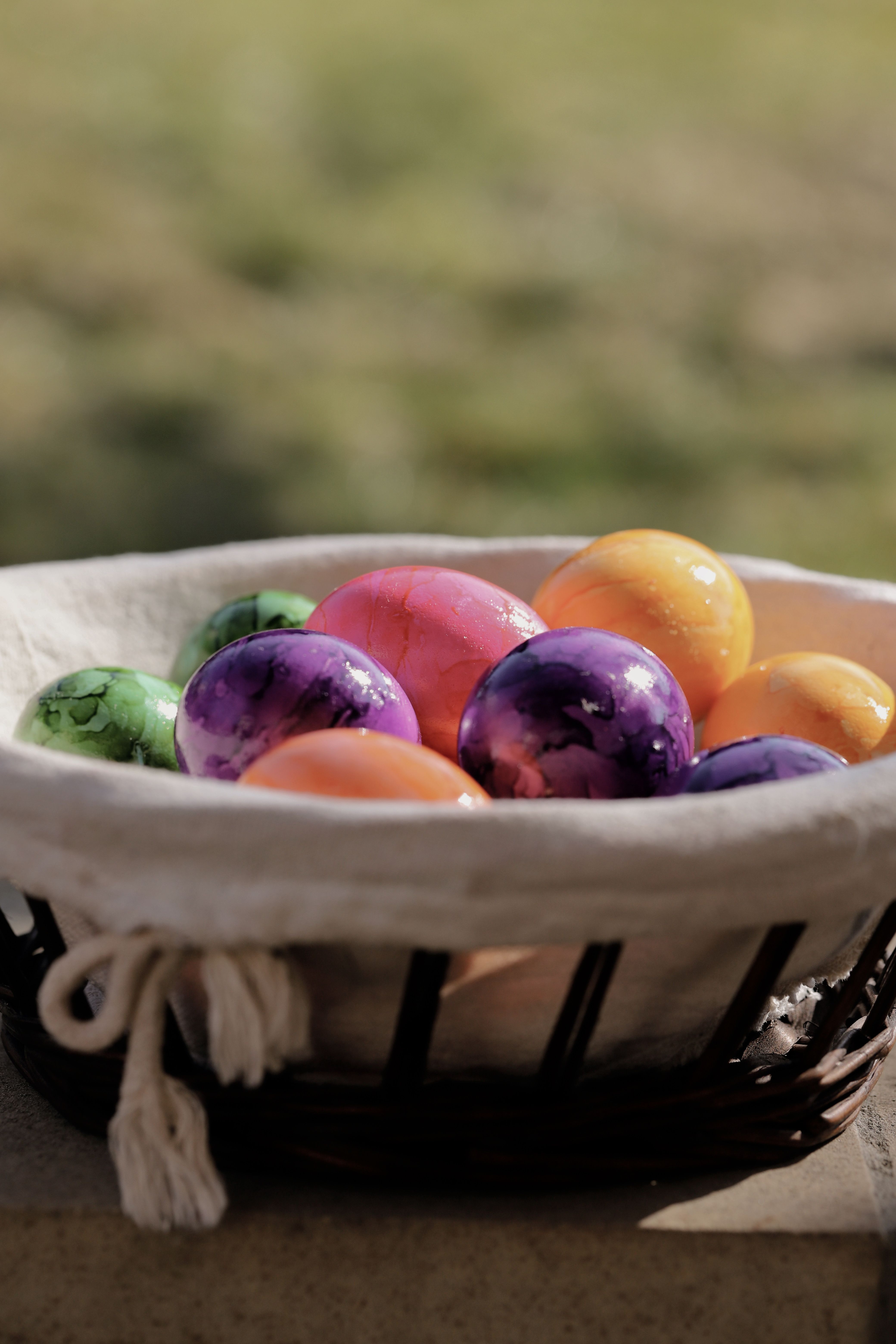Vibrant Easter Eggs in Woven Basket Outdoors · Free Stock Photo