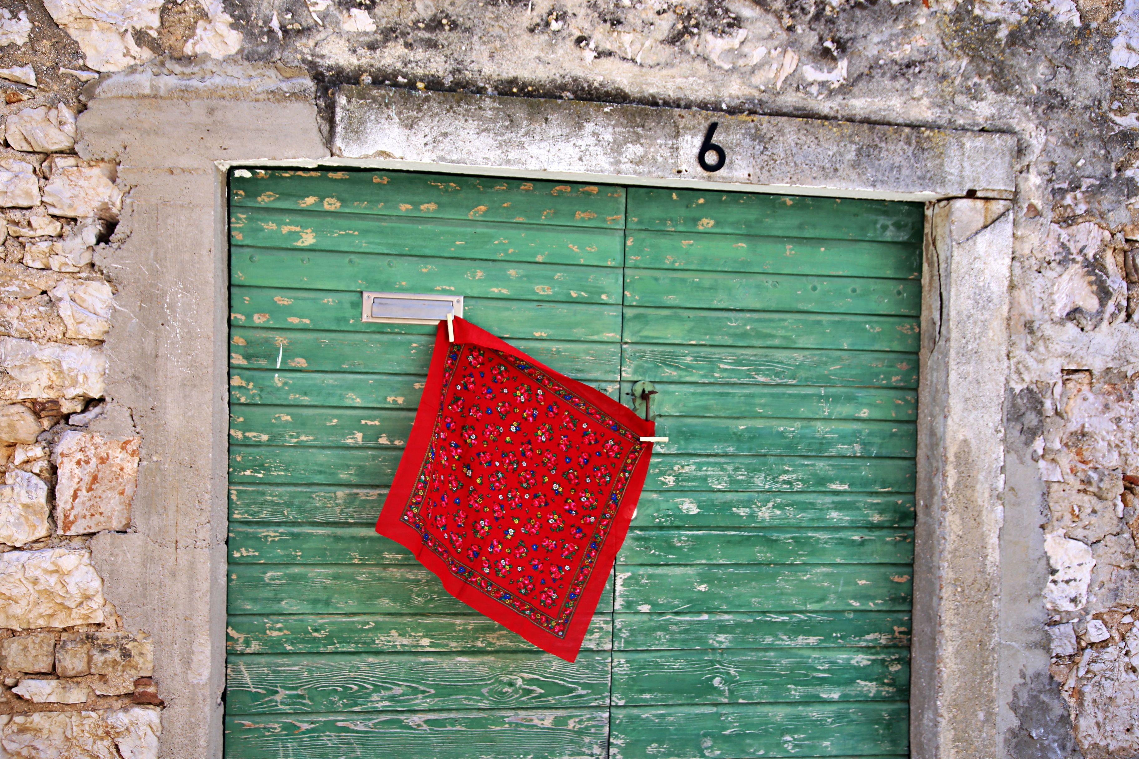 Rustic Green Door with Red Cloth Detail · Free Stock Photo