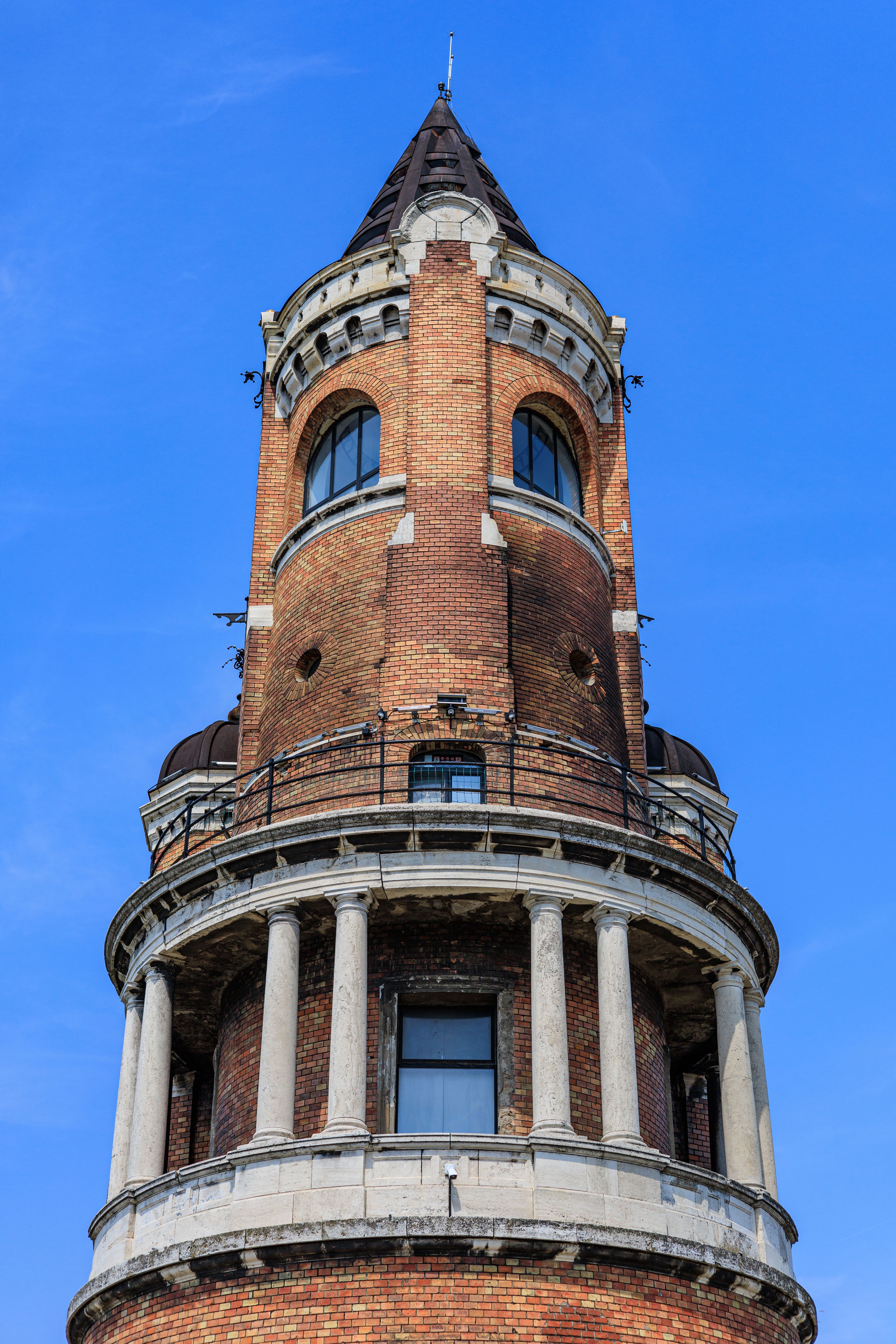 Historic Brick Tower Against Blue Sky · Free Stock Photo