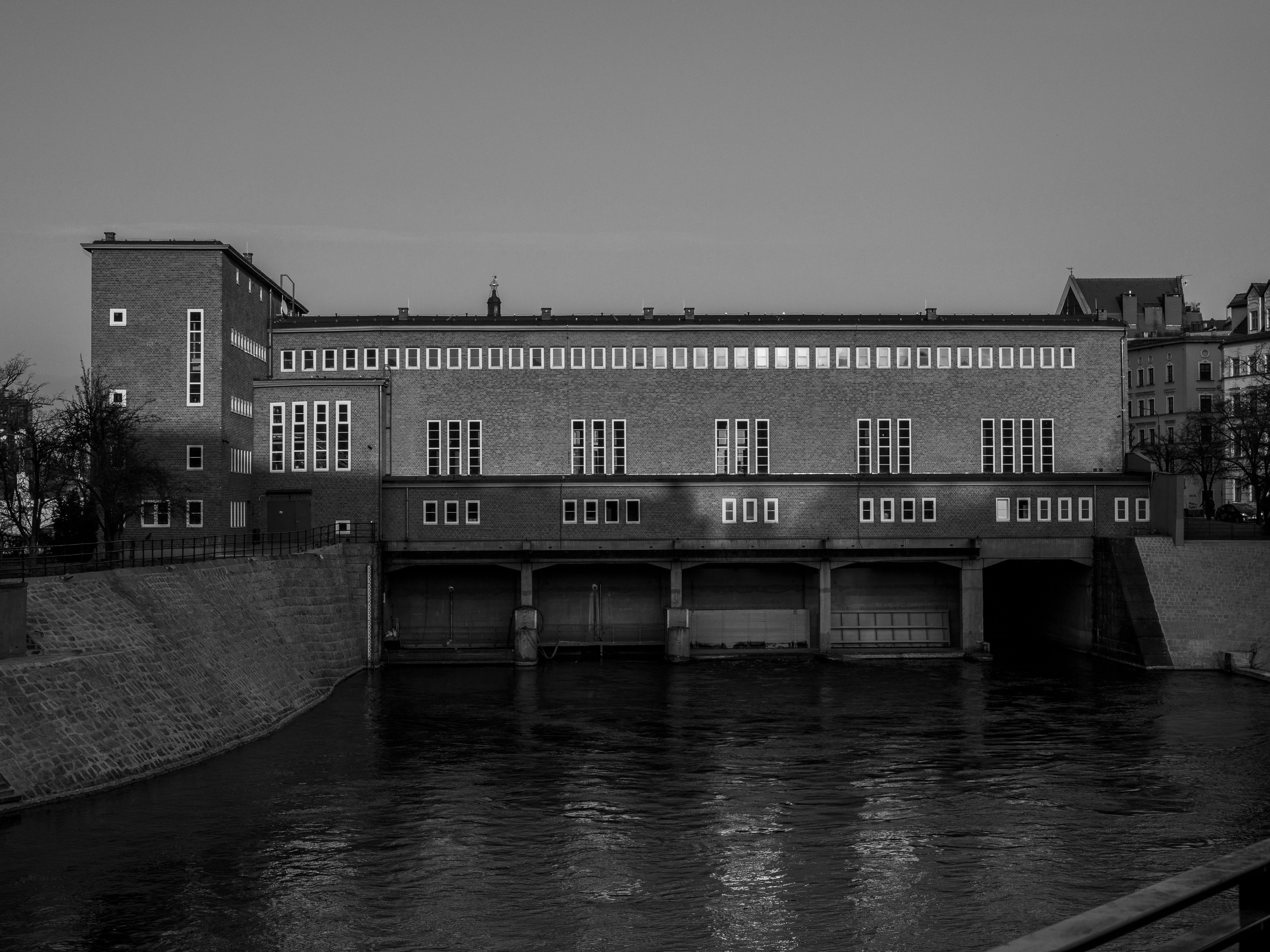 Historic Brick Building by a Riverside · Free Stock Photo
