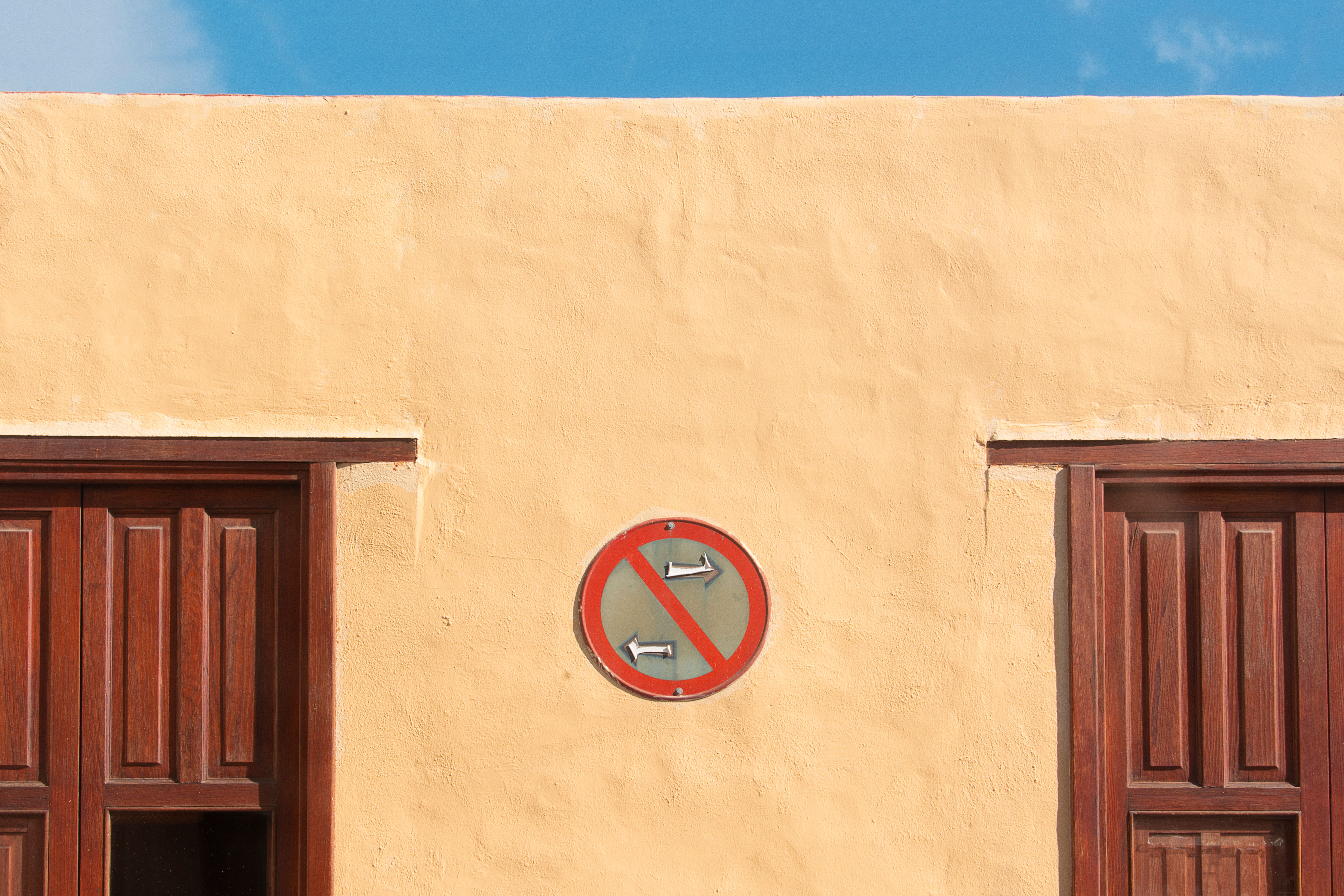 Minimalist Wall with No Entry Sign and Wooden Doors · Free Stock Photo