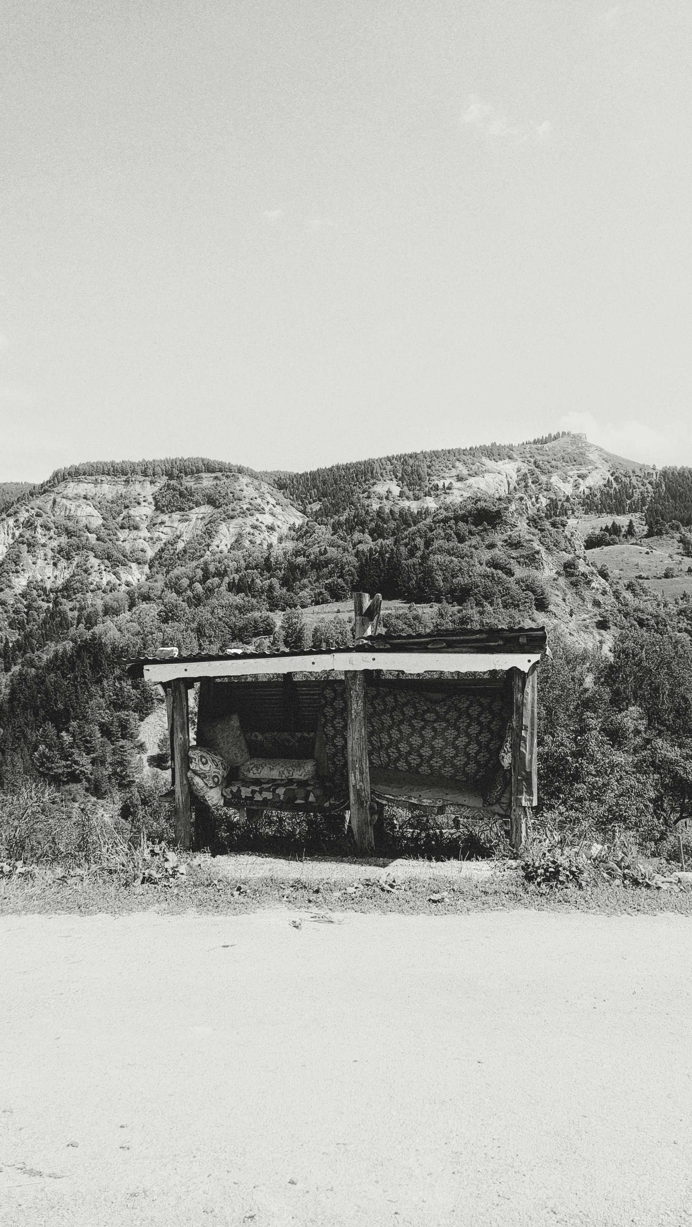 Rustic Bus Stop in Serene Mountain Landscape · Free Stock Photo