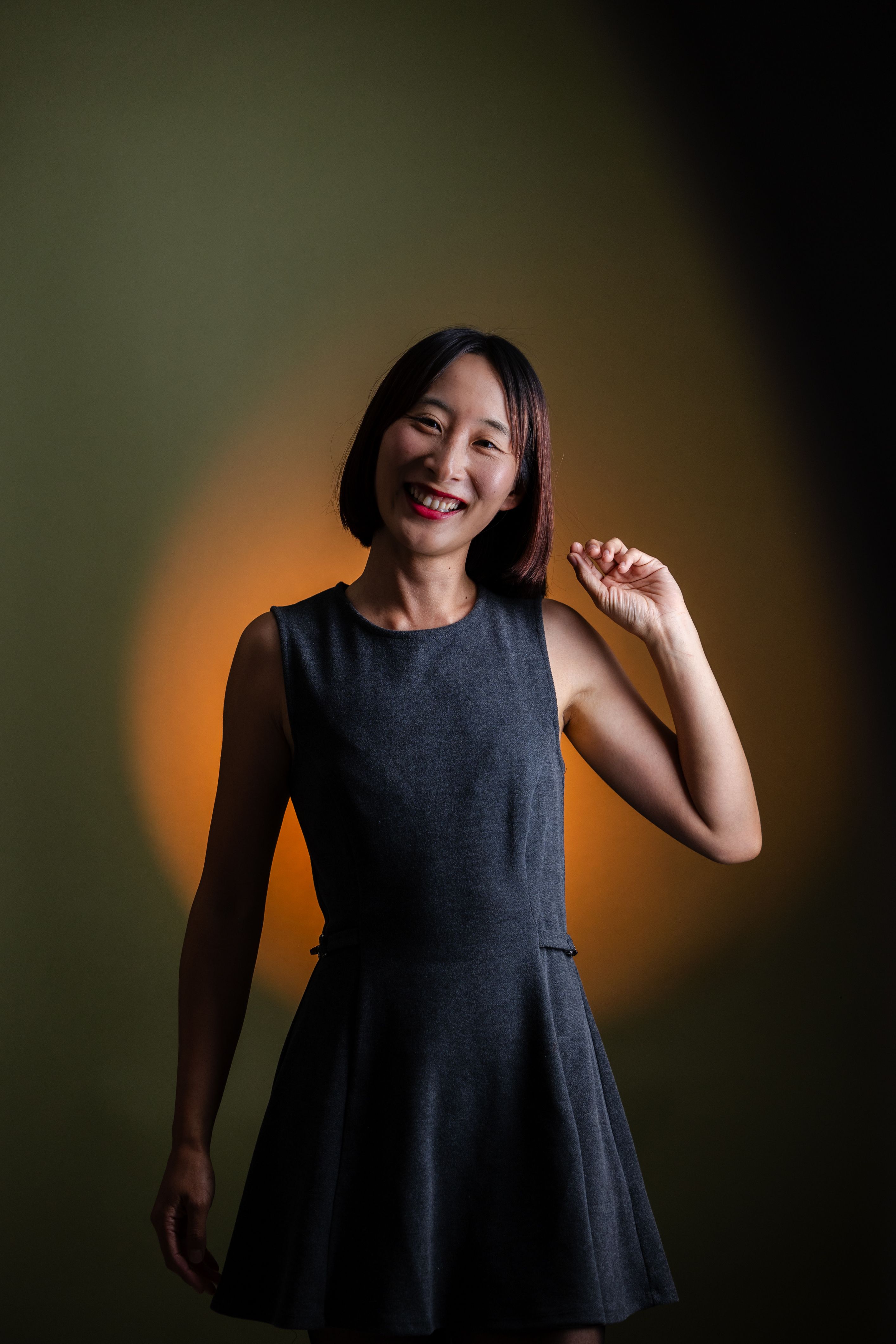 Cheerful Woman Posing in Studio Lighting · Free Stock Photo