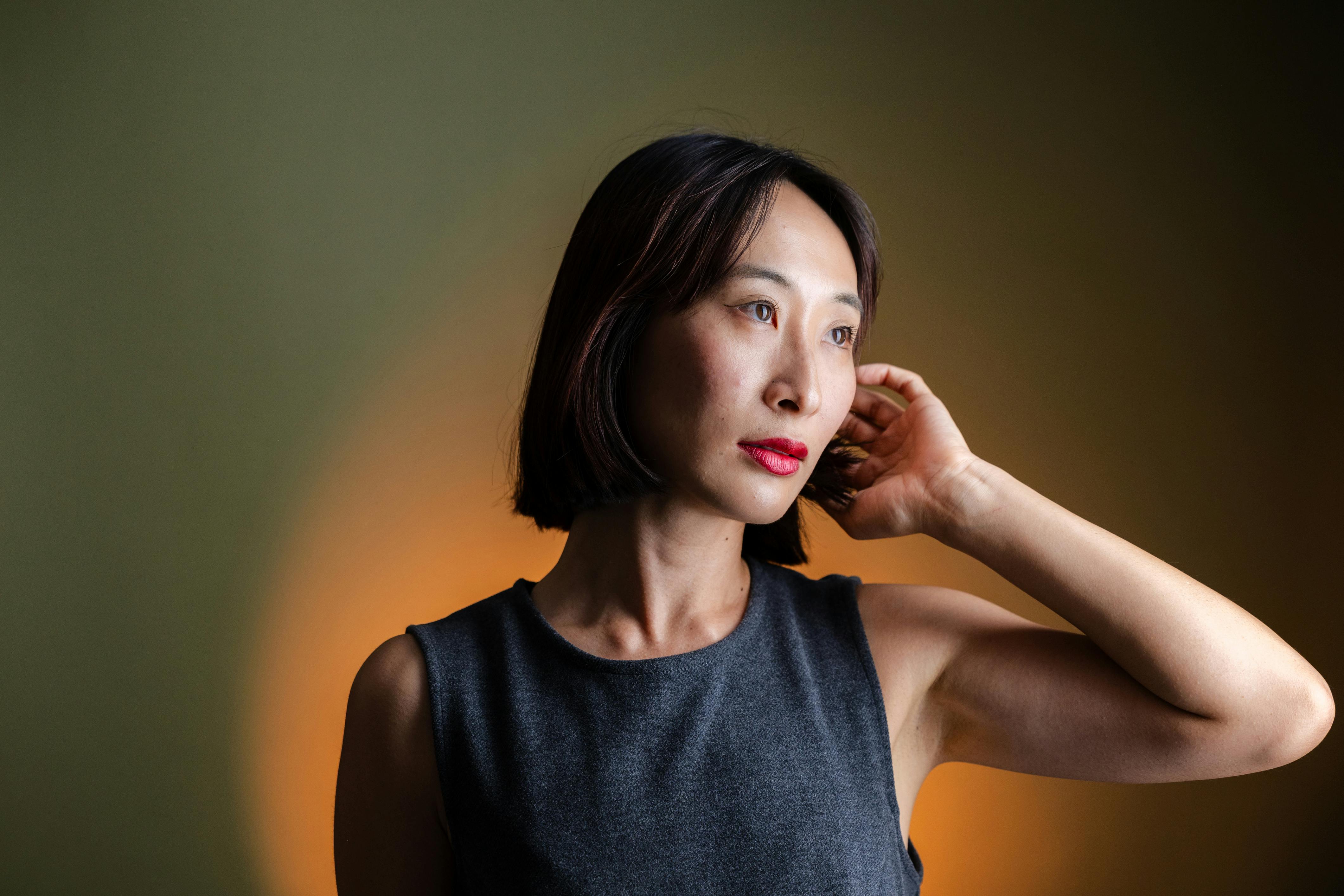 Contemplative Portrait of a Woman in Studio Lighting · Free Stock Photo