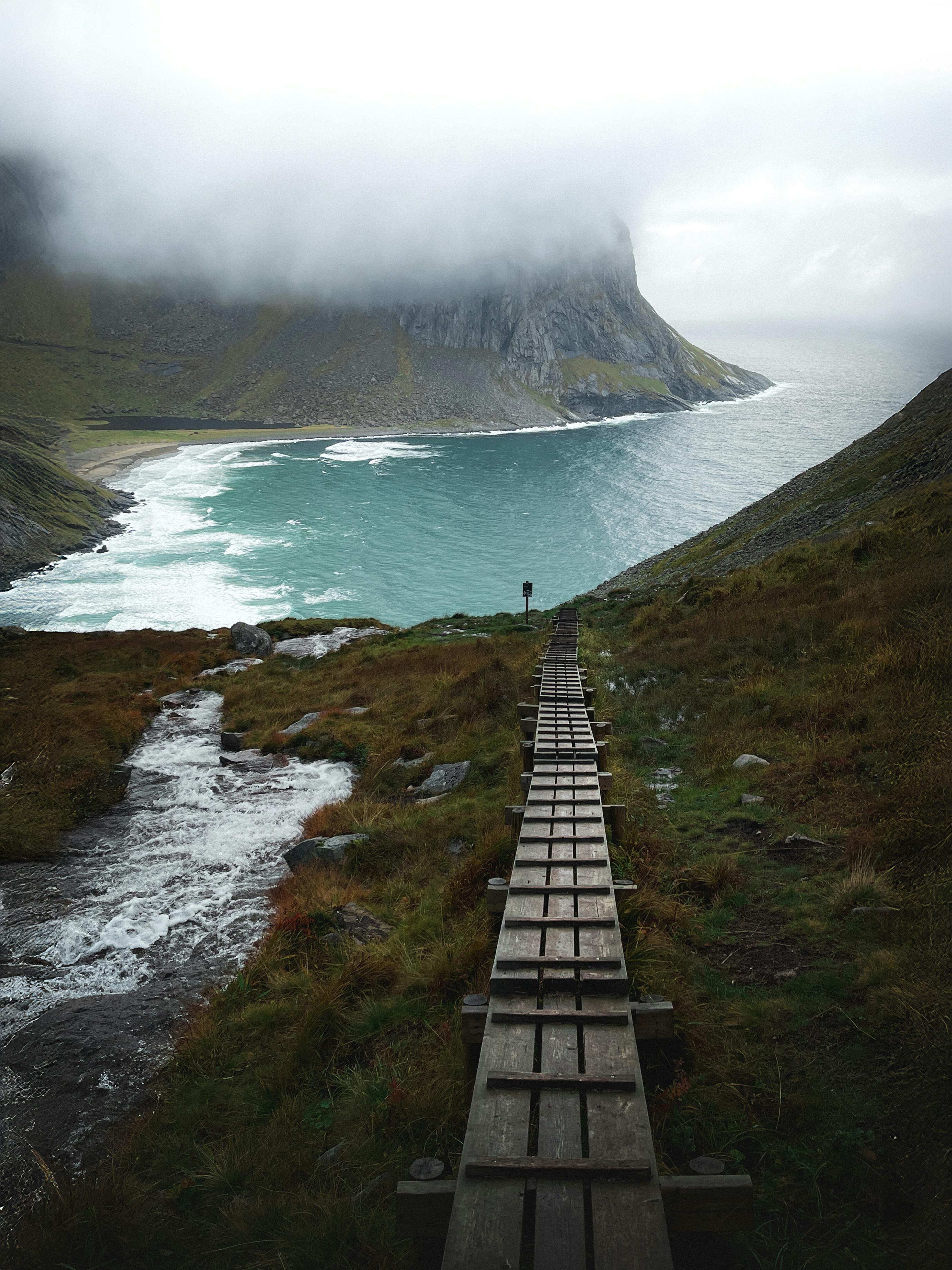 Scenic Wooden Walkway on Misty Nordic Coast · Free Stock Photo