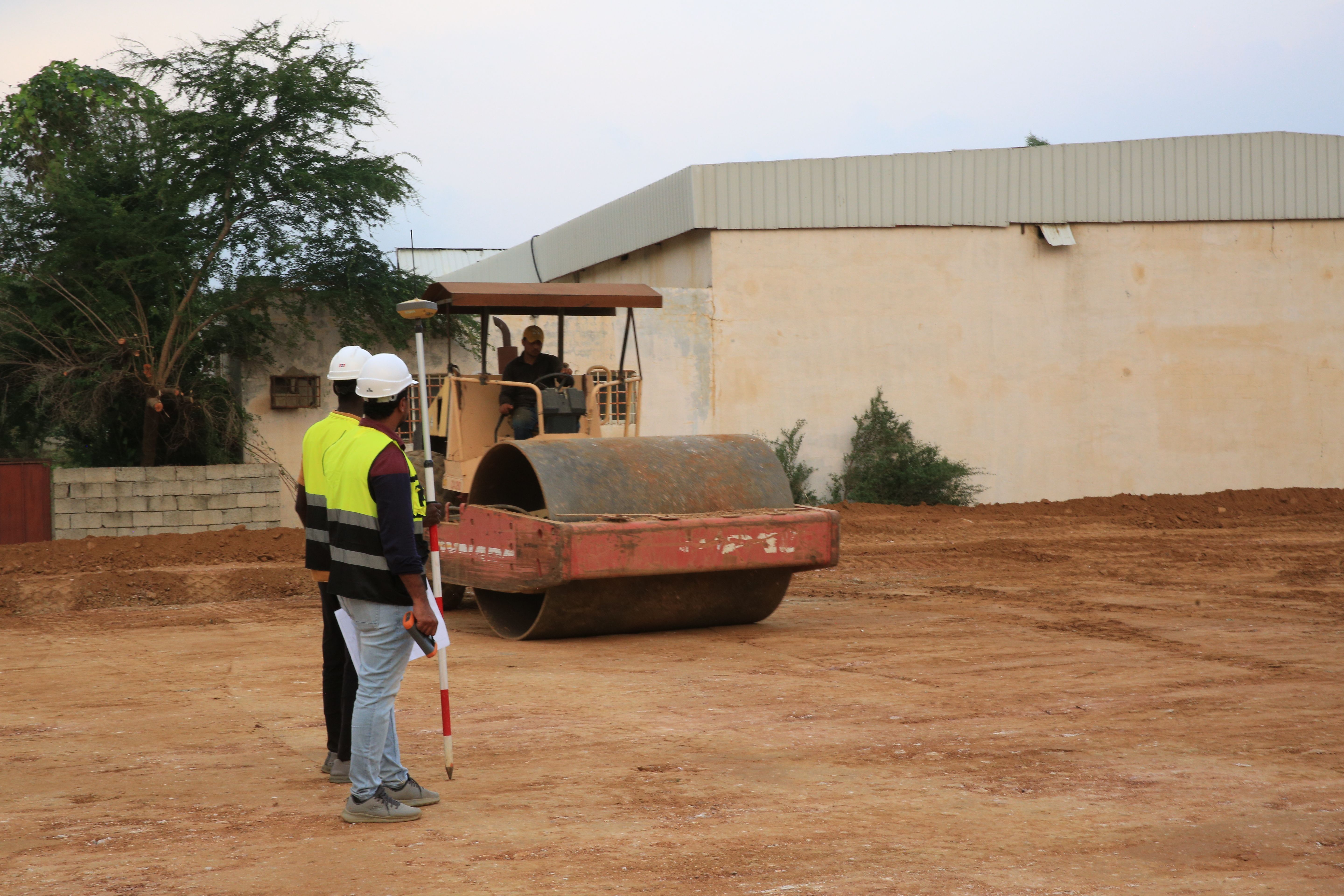 Construction Workers Operating Road Roller at Site · Free Stock Photo